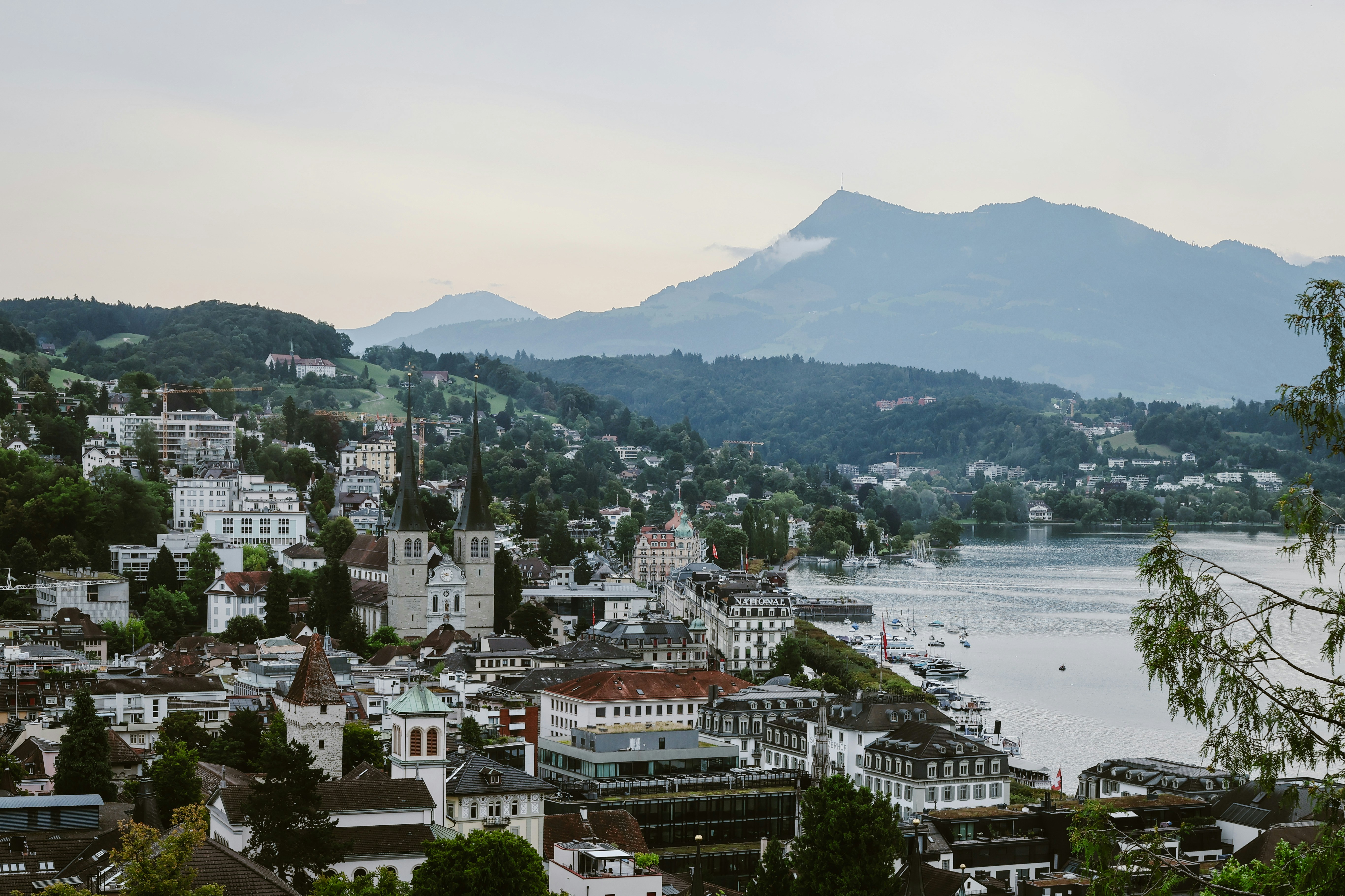 Town nestled on a hillside beside a tranquil lake.