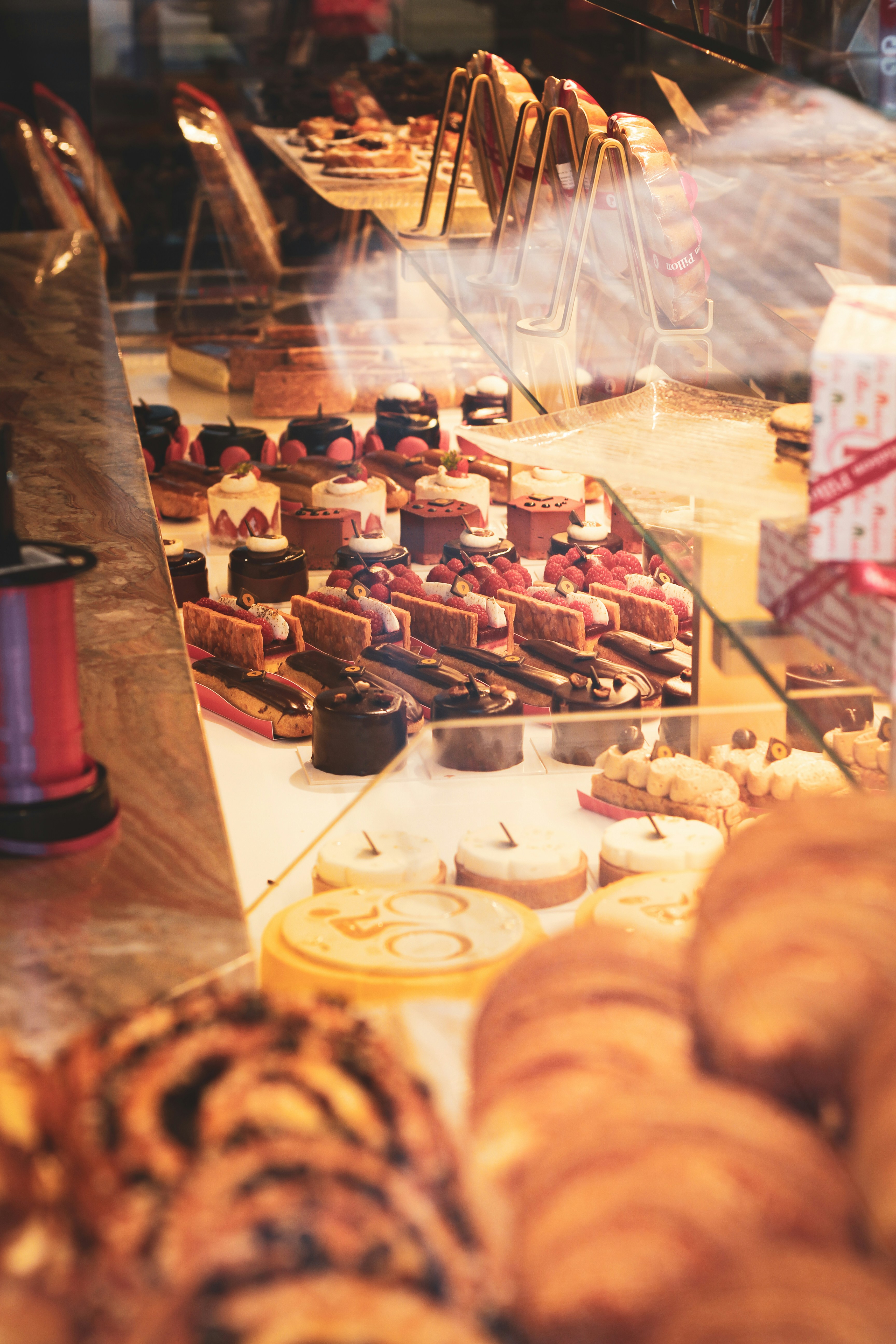 Assortment of pastries and cakes in a display case