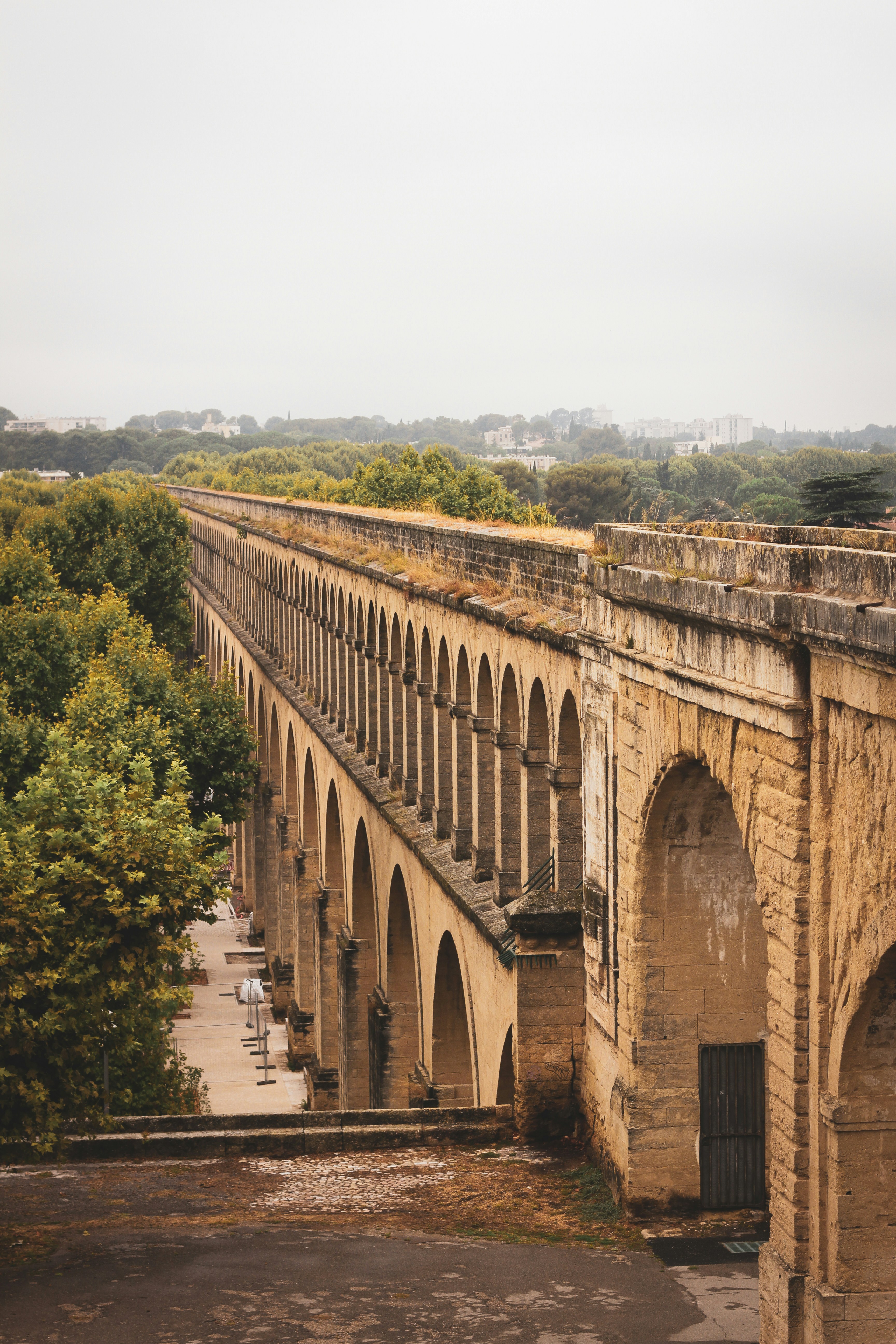 Riverside Arcades: A Time-Worn Viaduct Receding into Dawn Mist