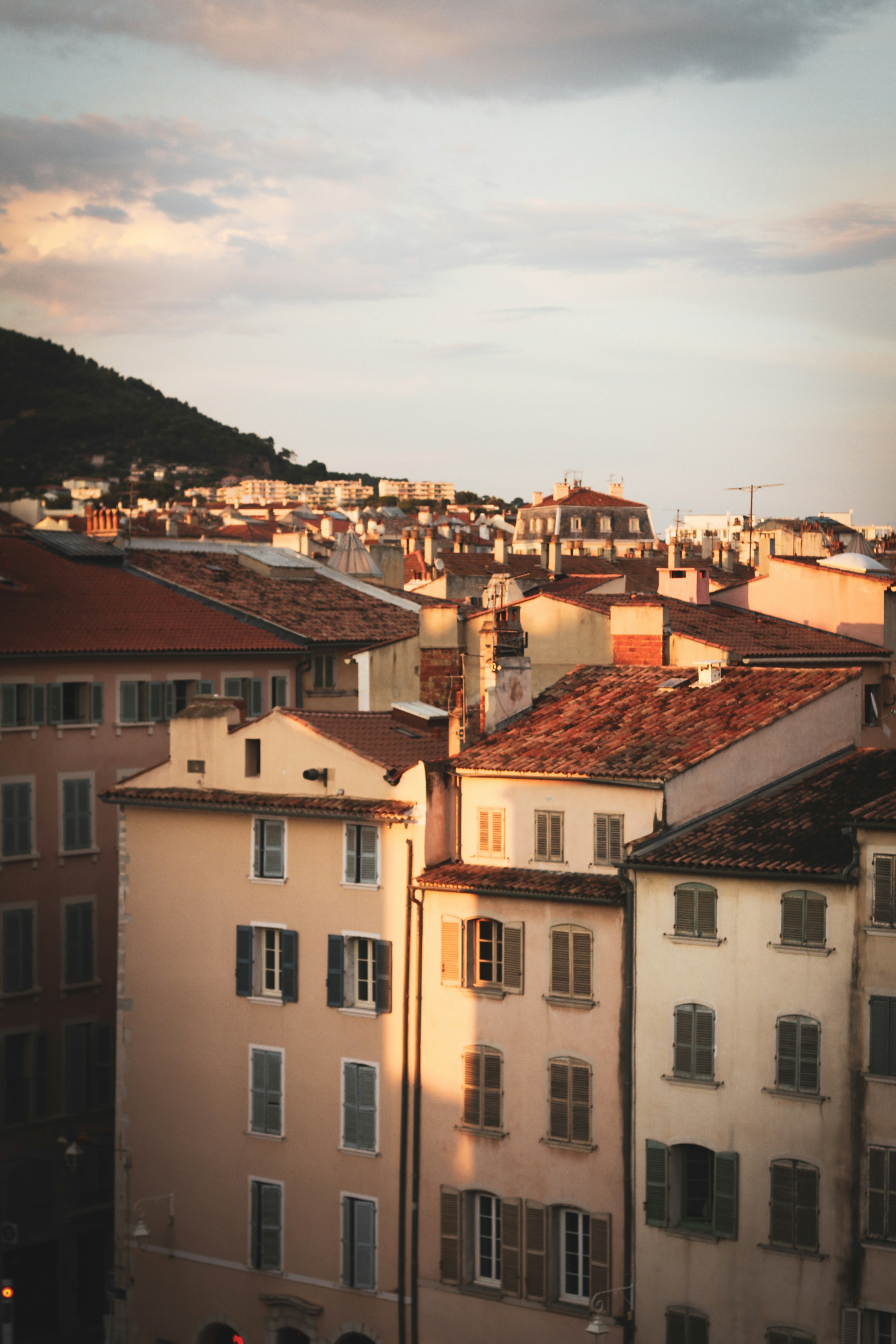 Buildings with terracotta roofs under a soft sky.