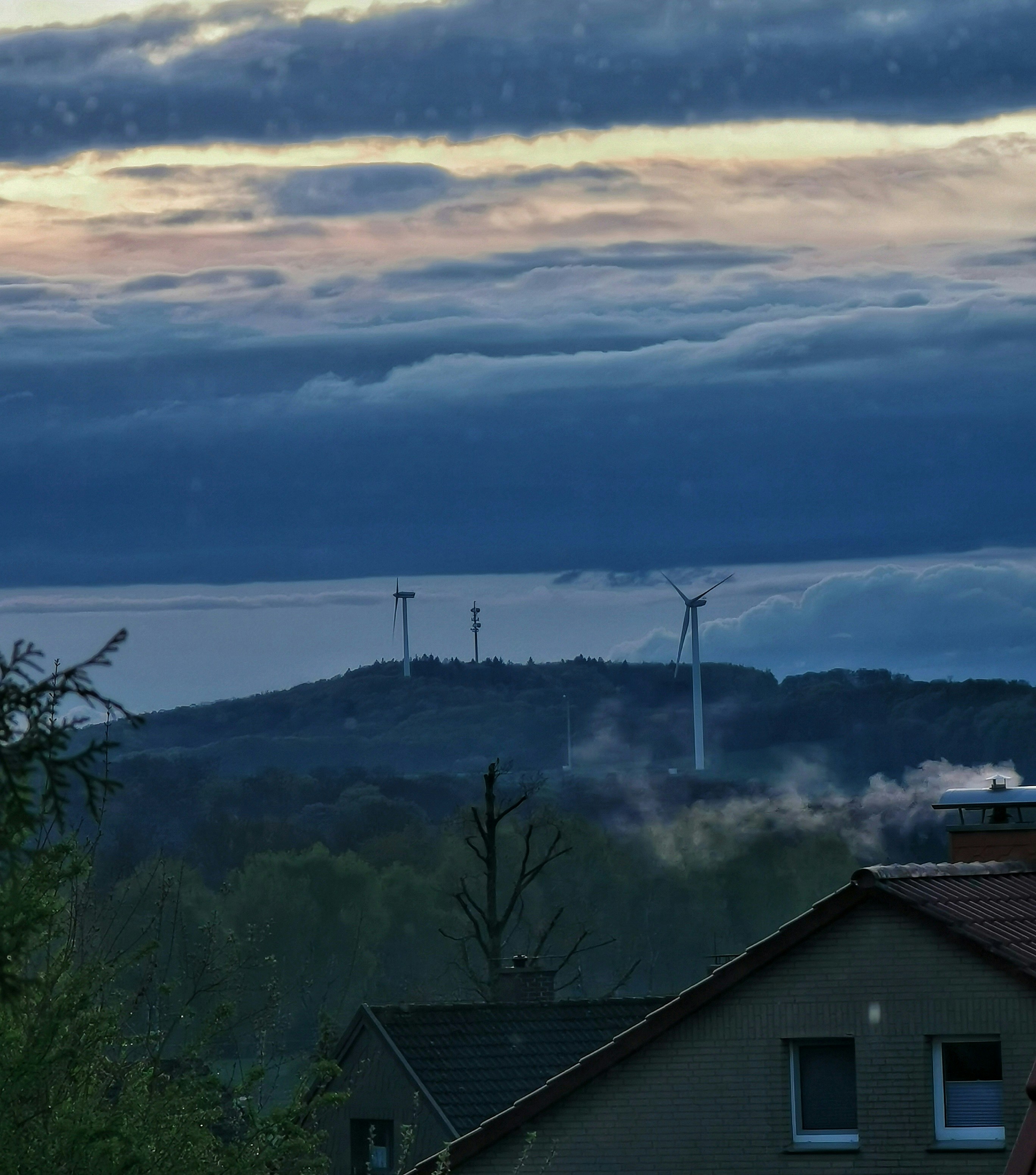 Wind turbines on a hill at dusk