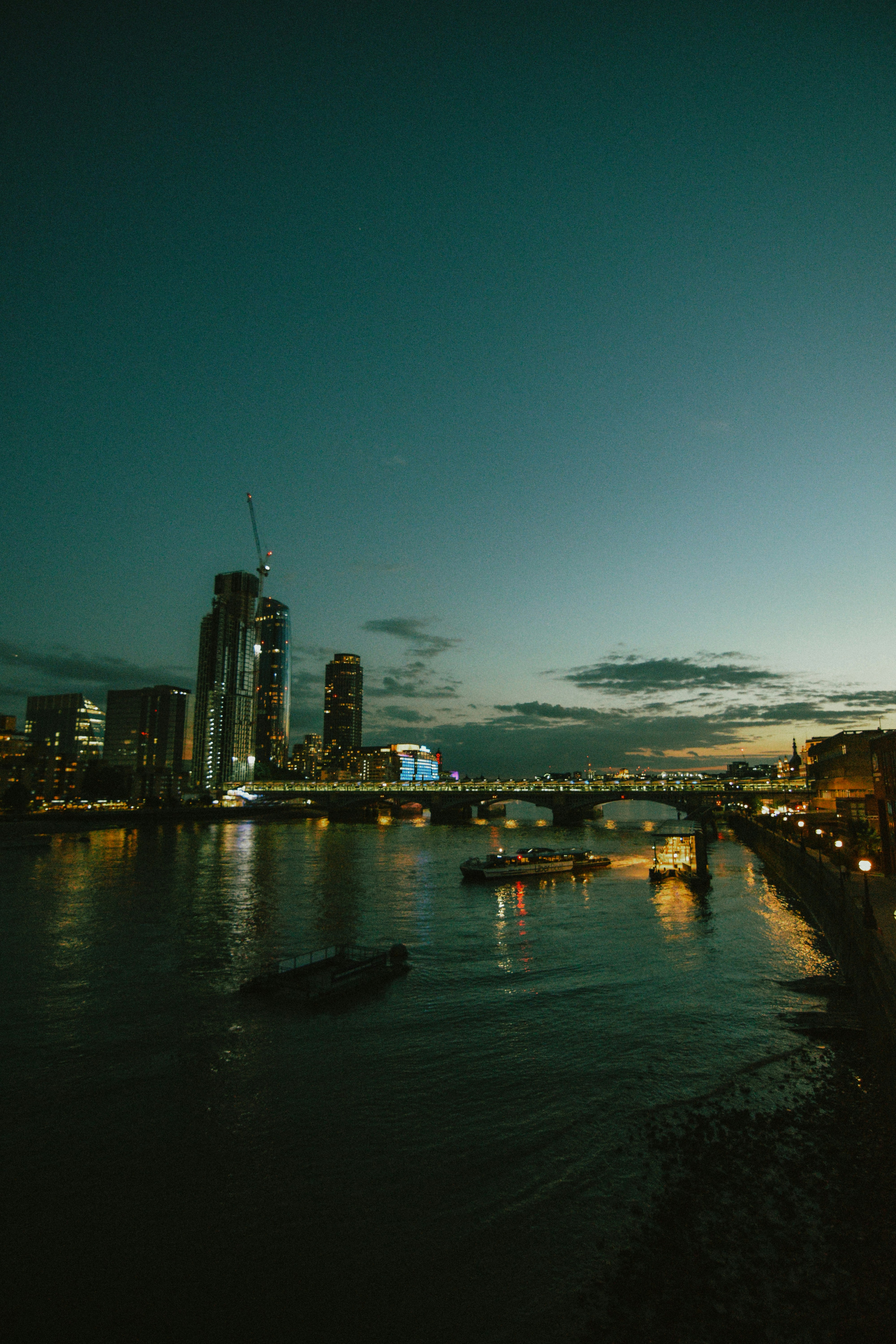 City skyline with river and bridge at dusk