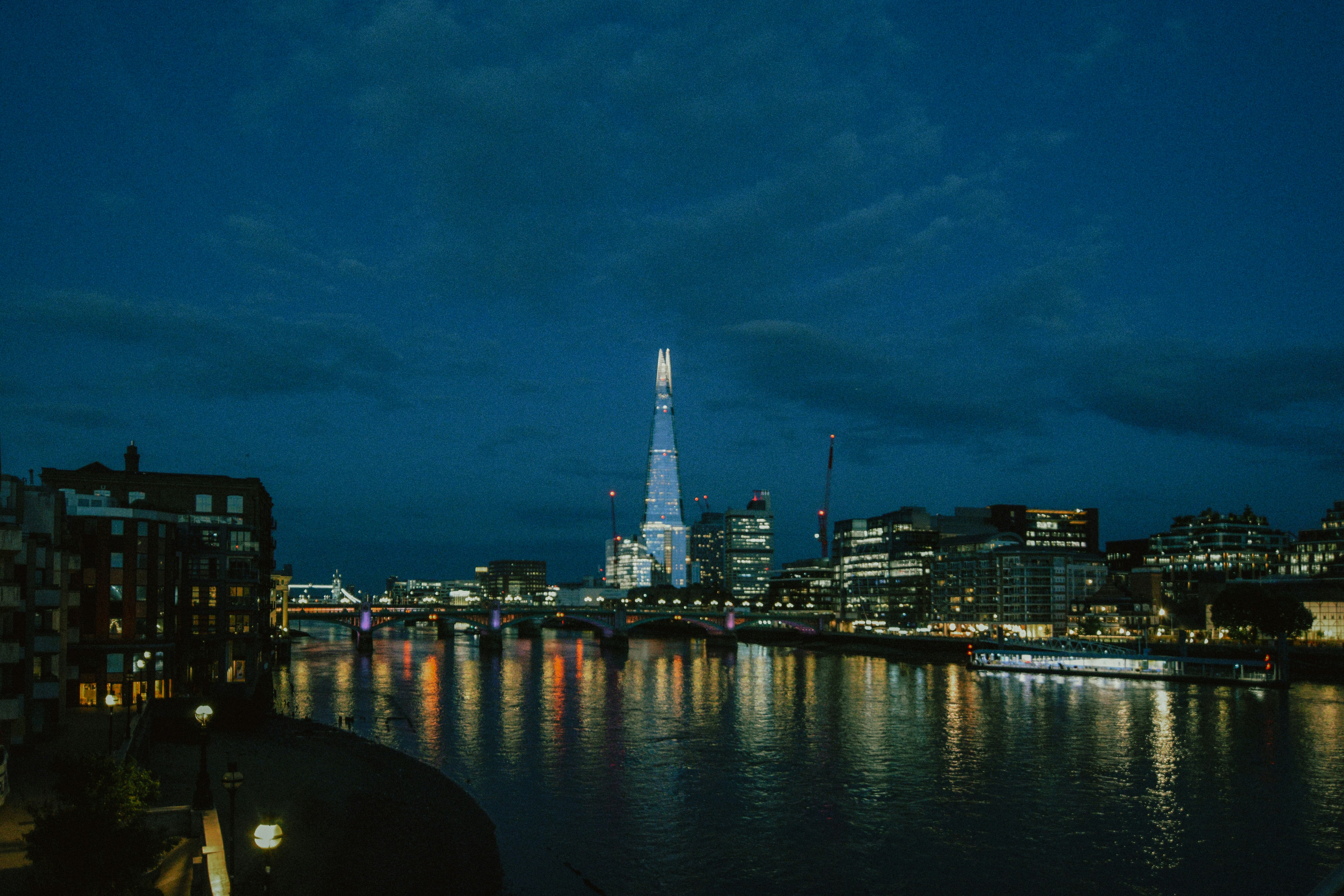 Cityscape with river and illuminated buildings at night