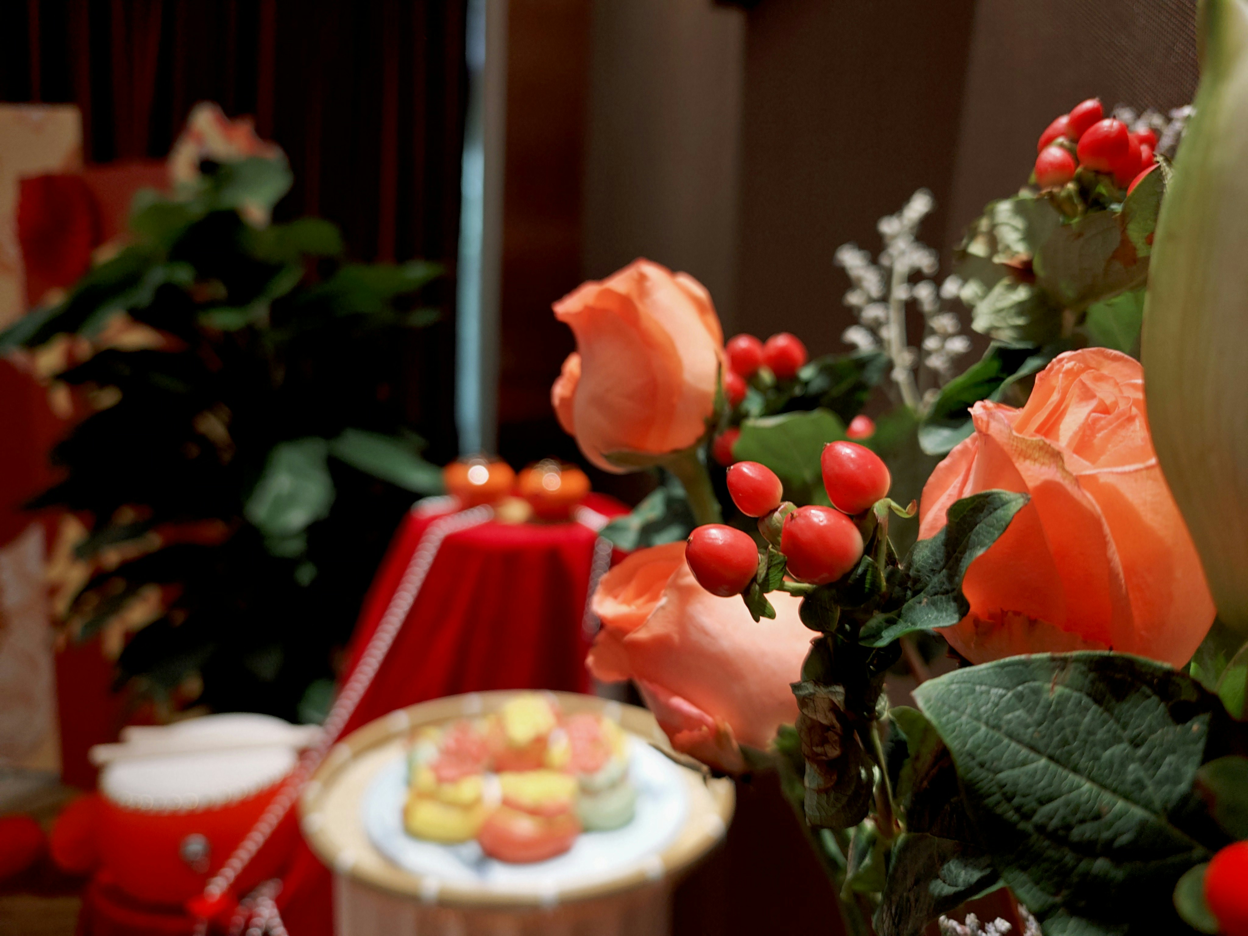Orange roses and berries in a floral arrangement