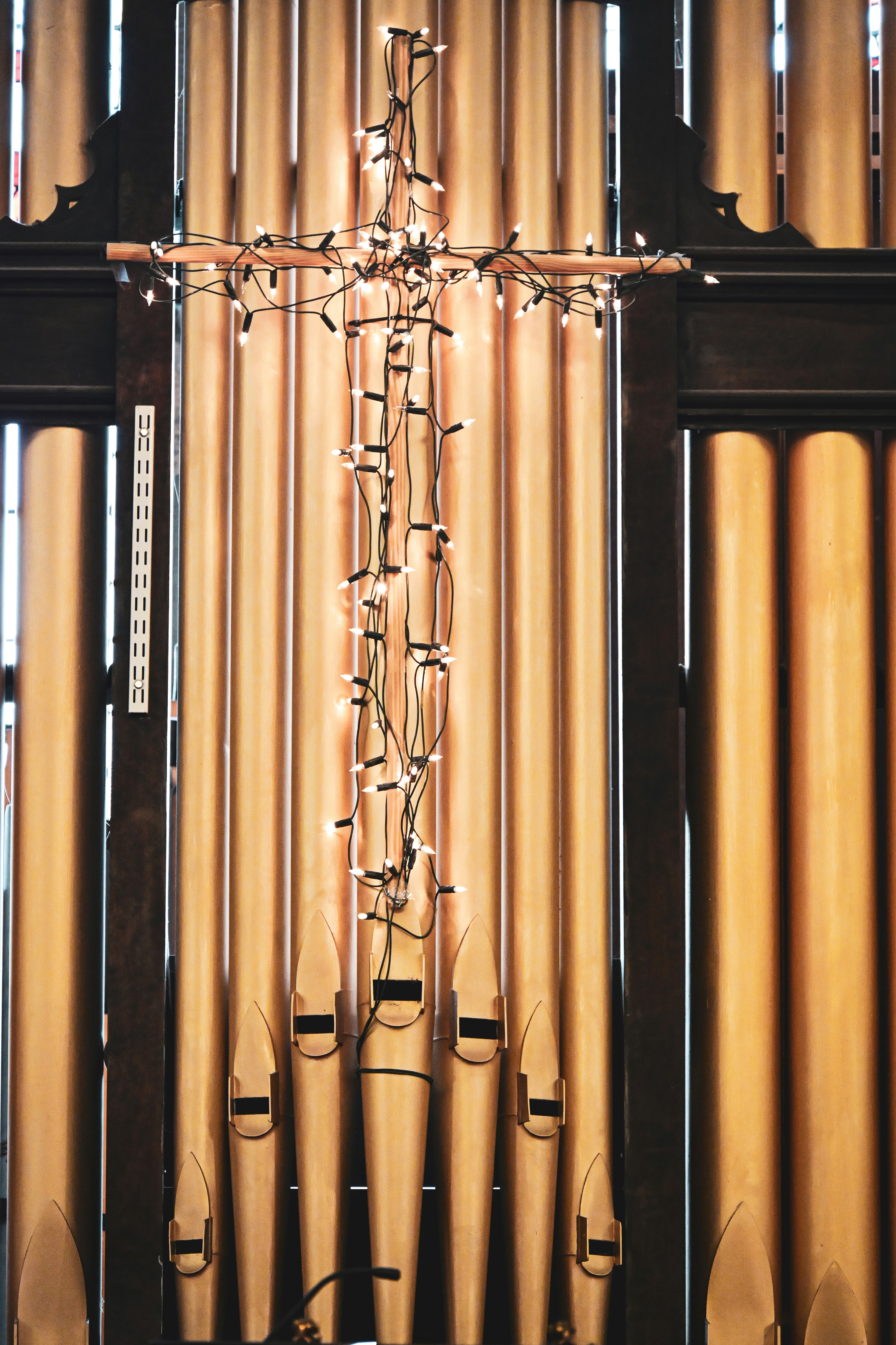 Illuminated Harmony: A Cross Amidst the Pipes