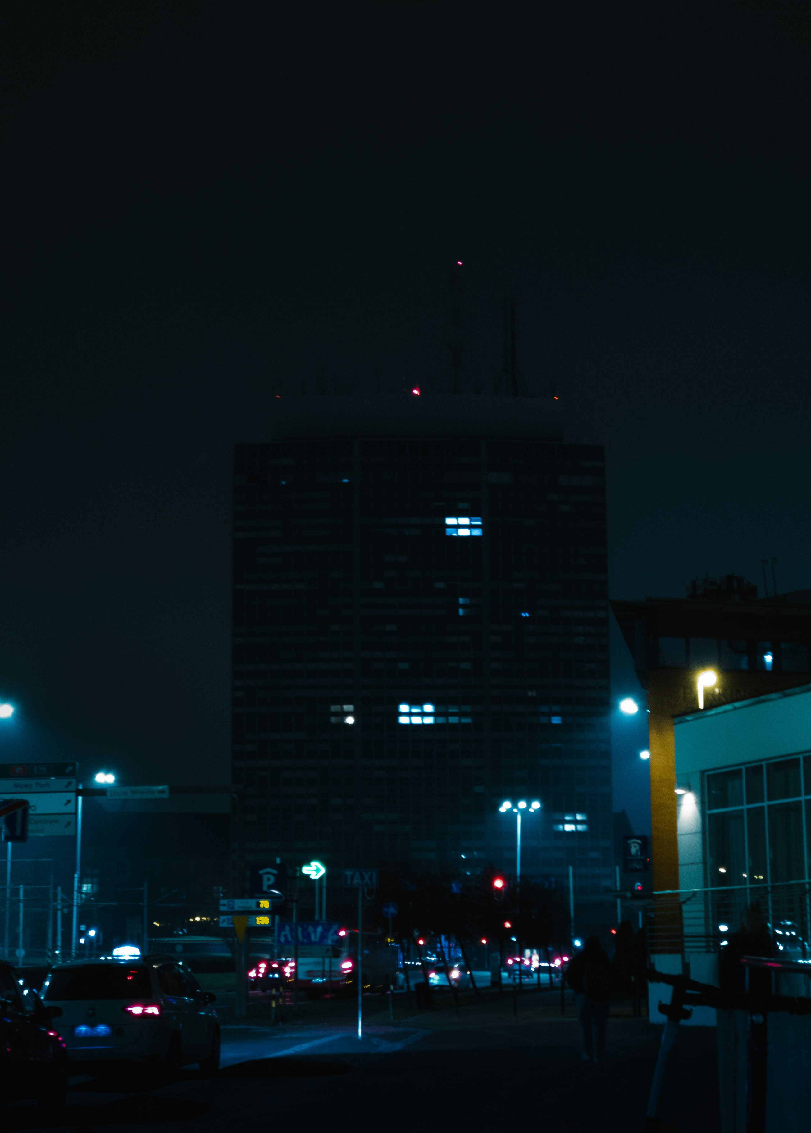 2022 | Dark skyscraper with illuminated windows at night.