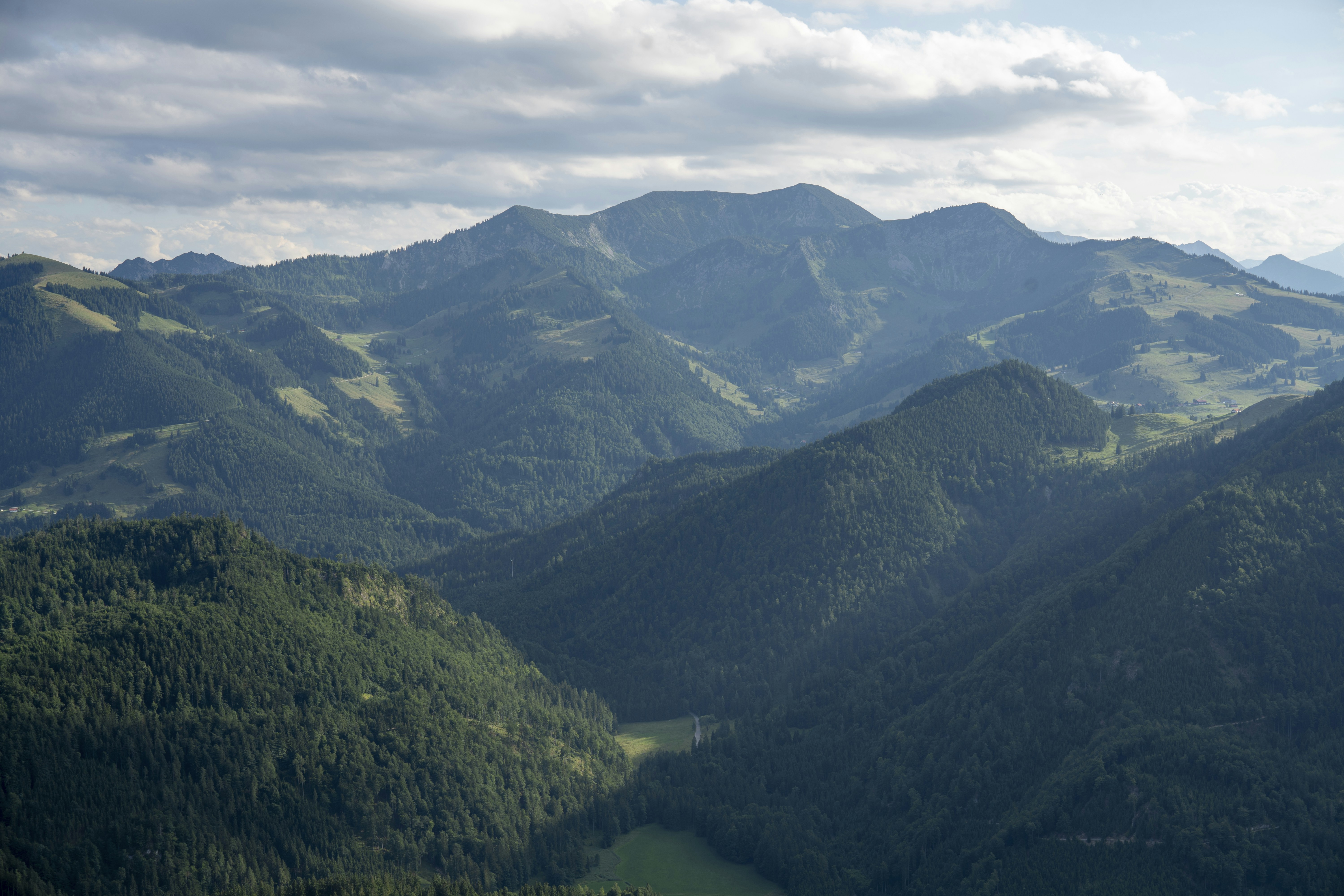 Lush green mountains under a cloudy sky