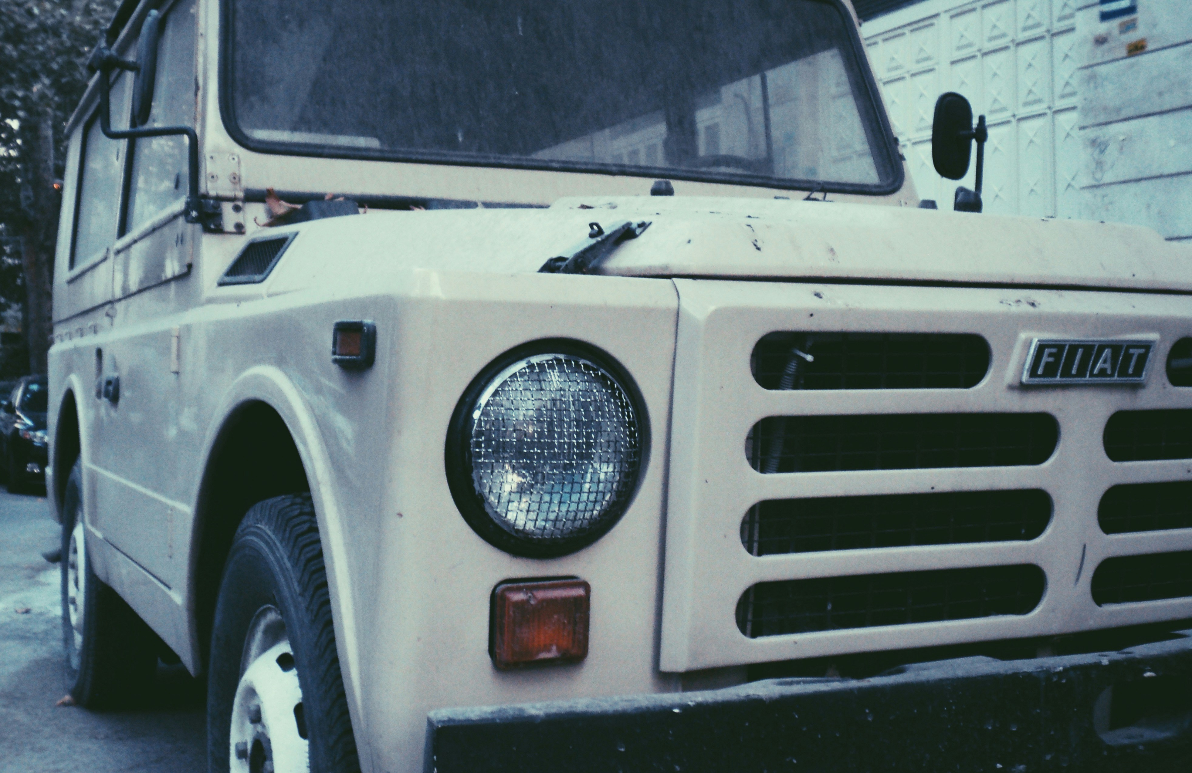 The quiet dignity of a classic machine. | A vintage beige fiat van parked outdoors