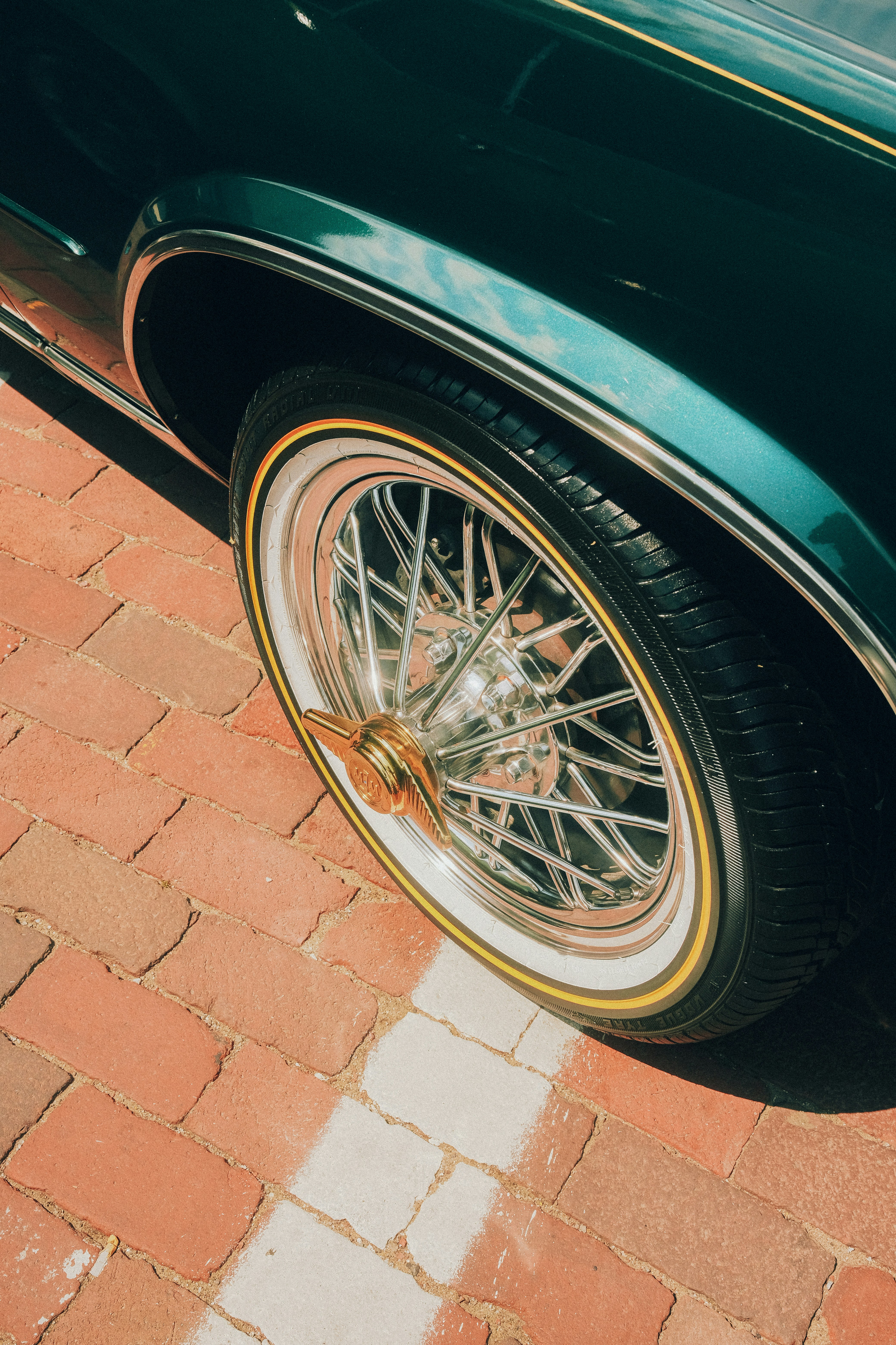 Close-up of a vintage car wheel on brick pavement photo – Free ...