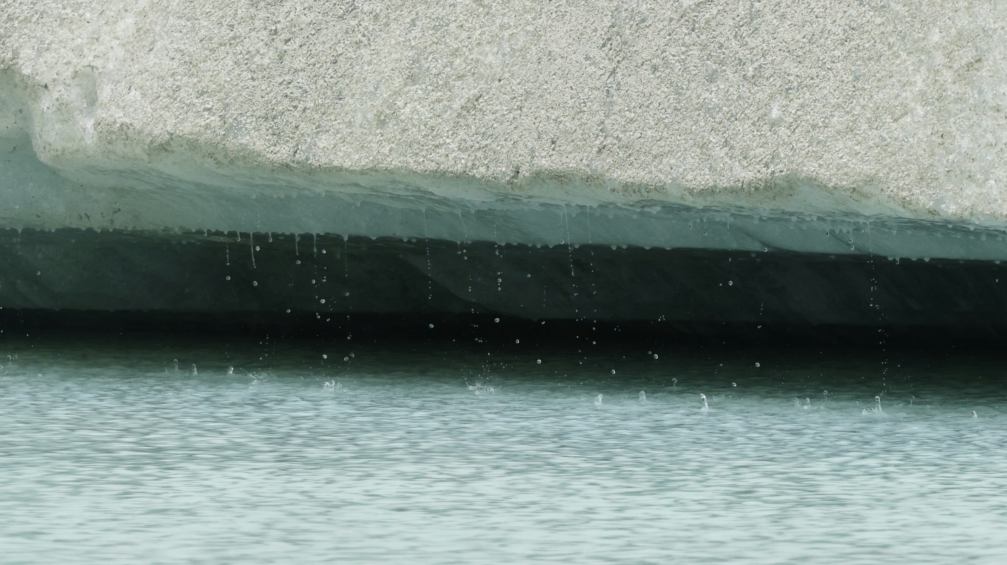 Water dripping from ice into calm water. photo – Free Glacier Image on ...