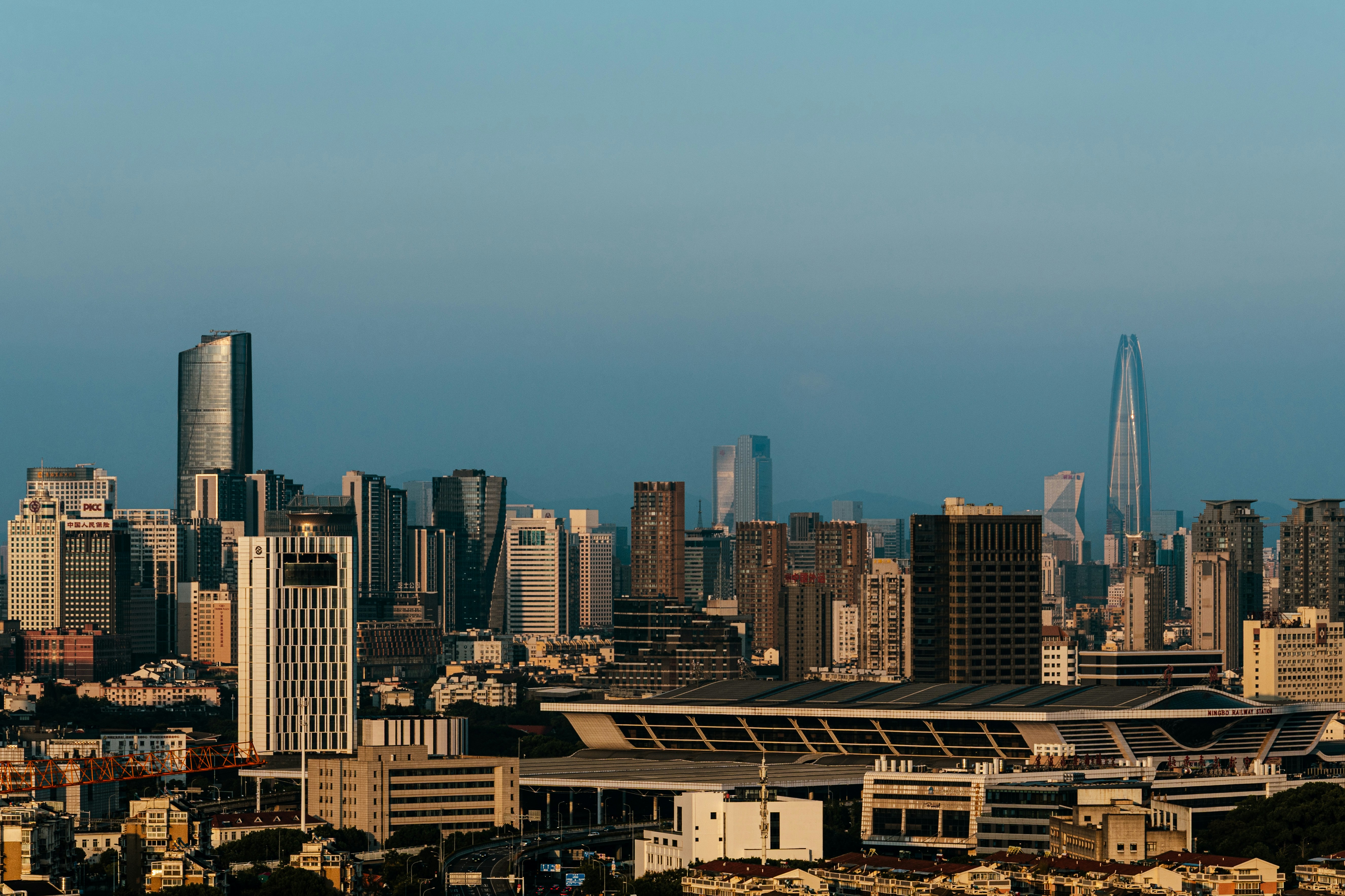 Shocked by the architecture of Ningbo, China at dusk | Modern cityscape with tall buildings under clear sky.