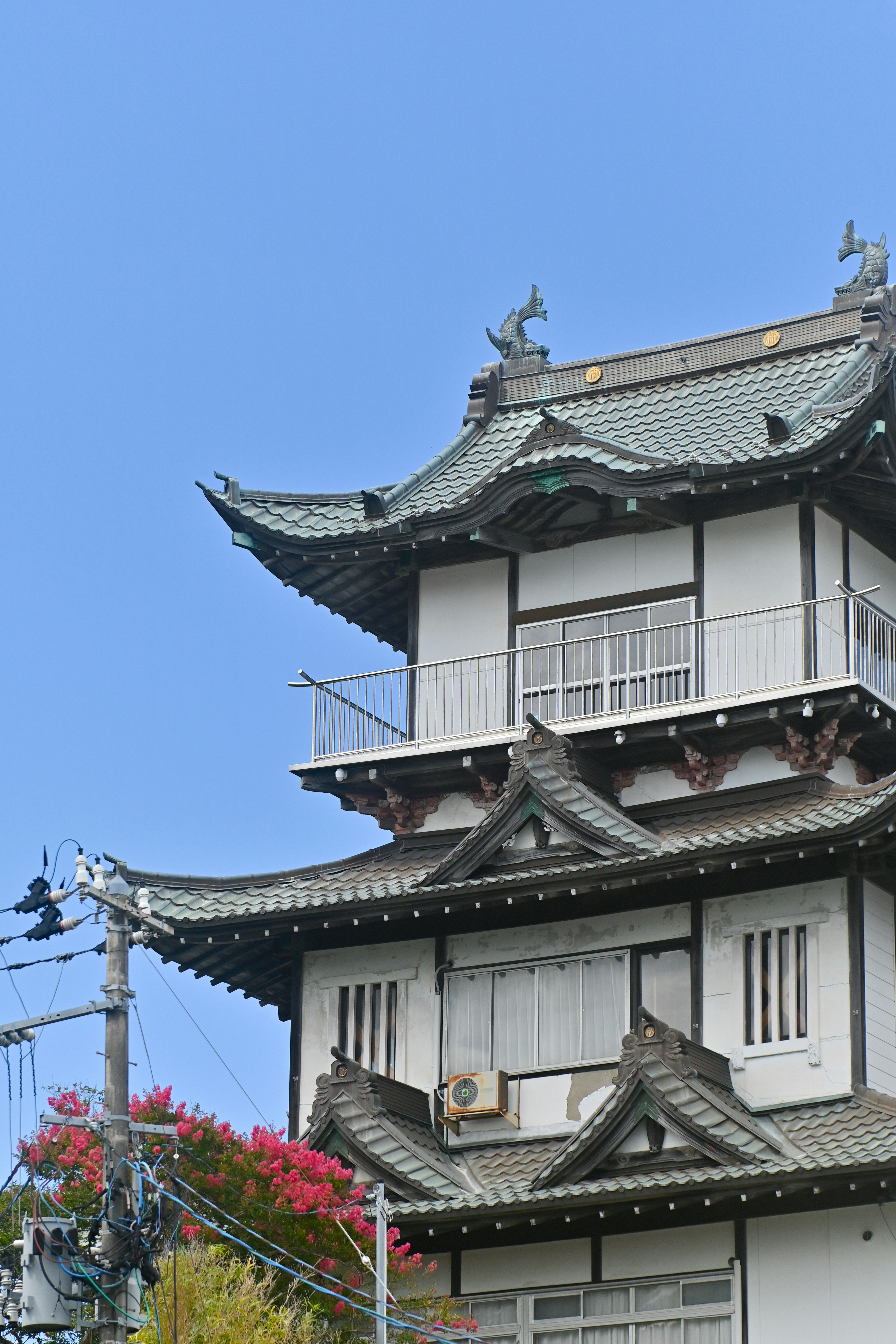 Traditional japanese building with layered roofs against sky