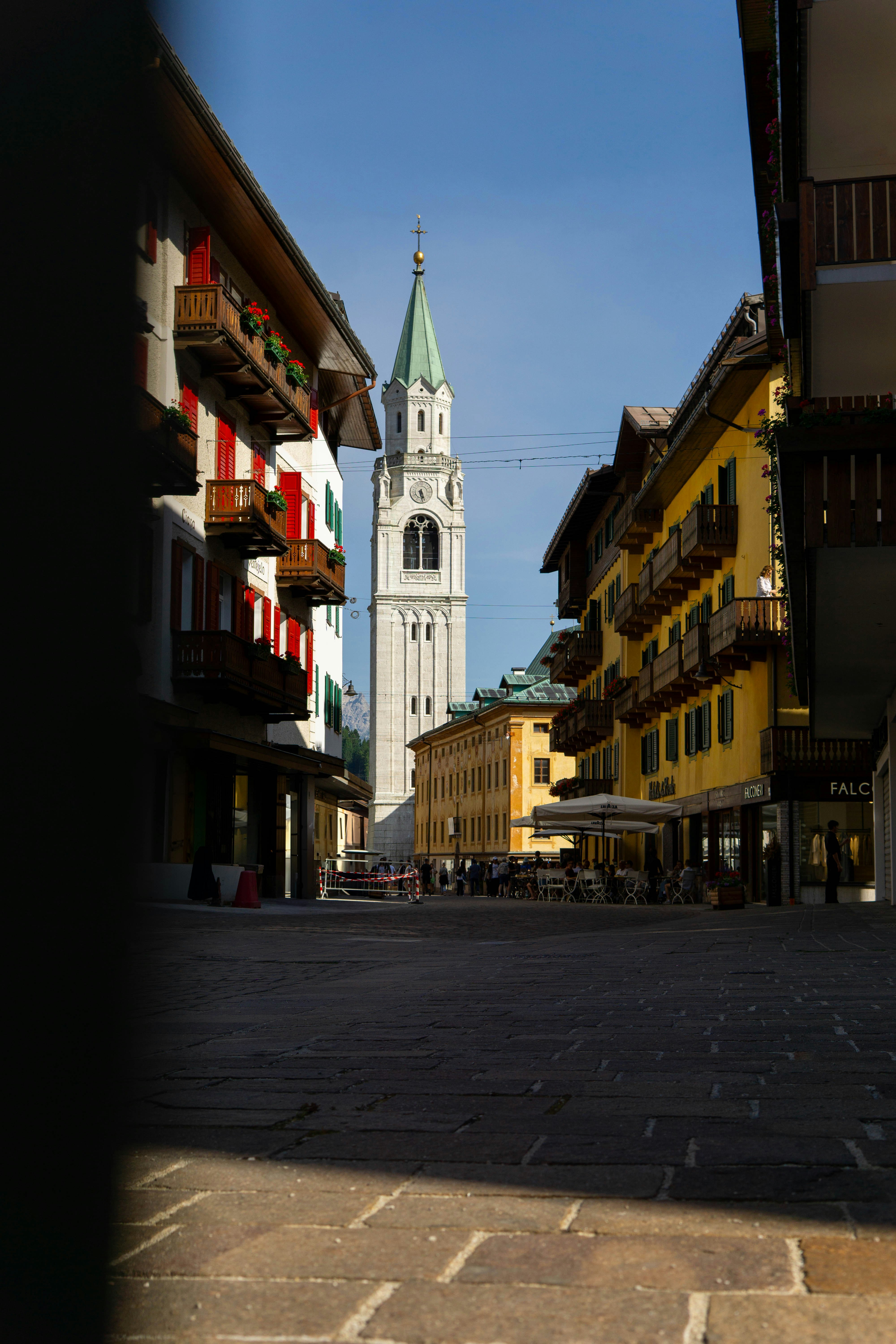 Old church in a small town in Italy | Tall church tower dominates a european town square.