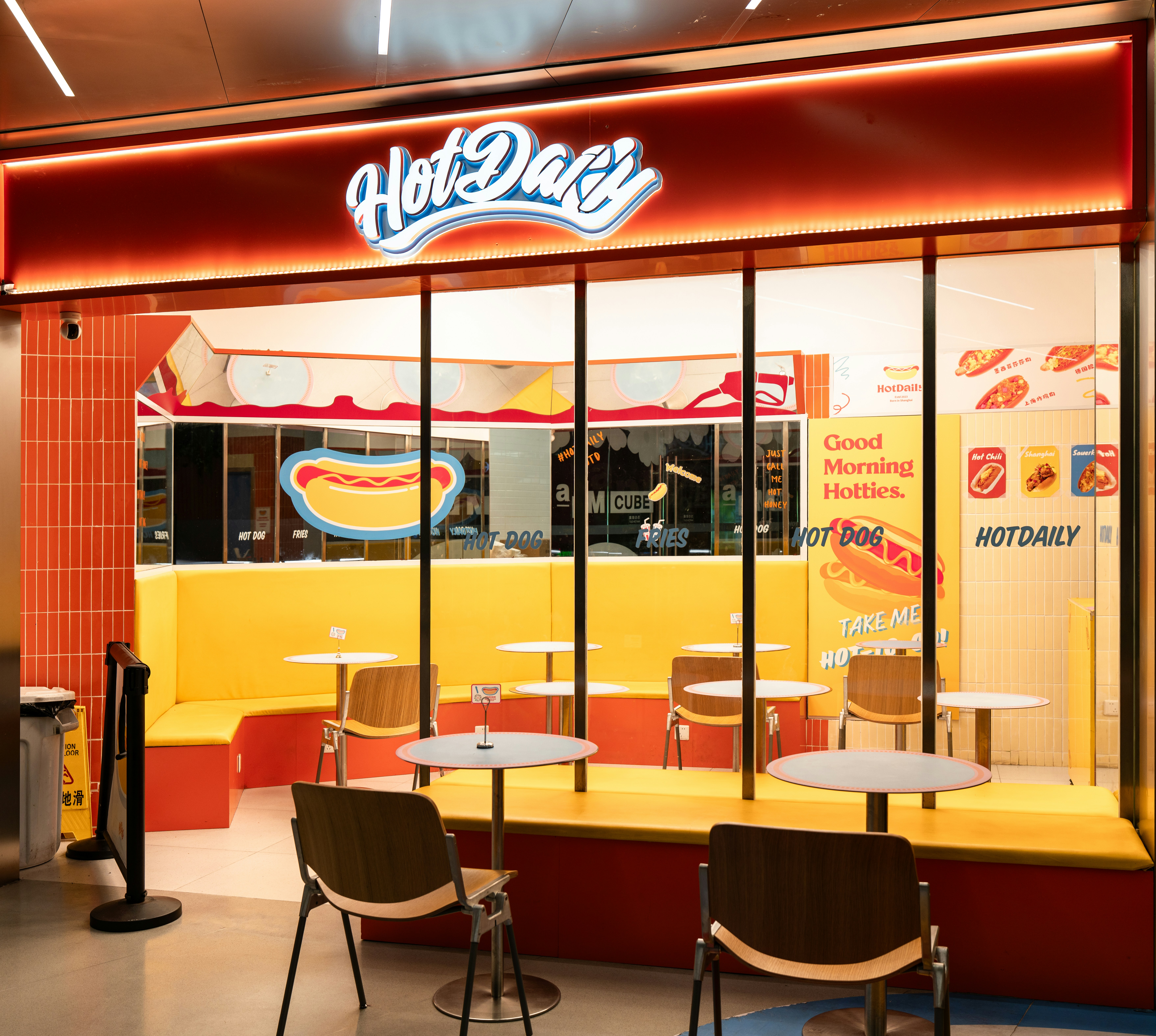 Hot dogz restaurant storefront with yellow seating