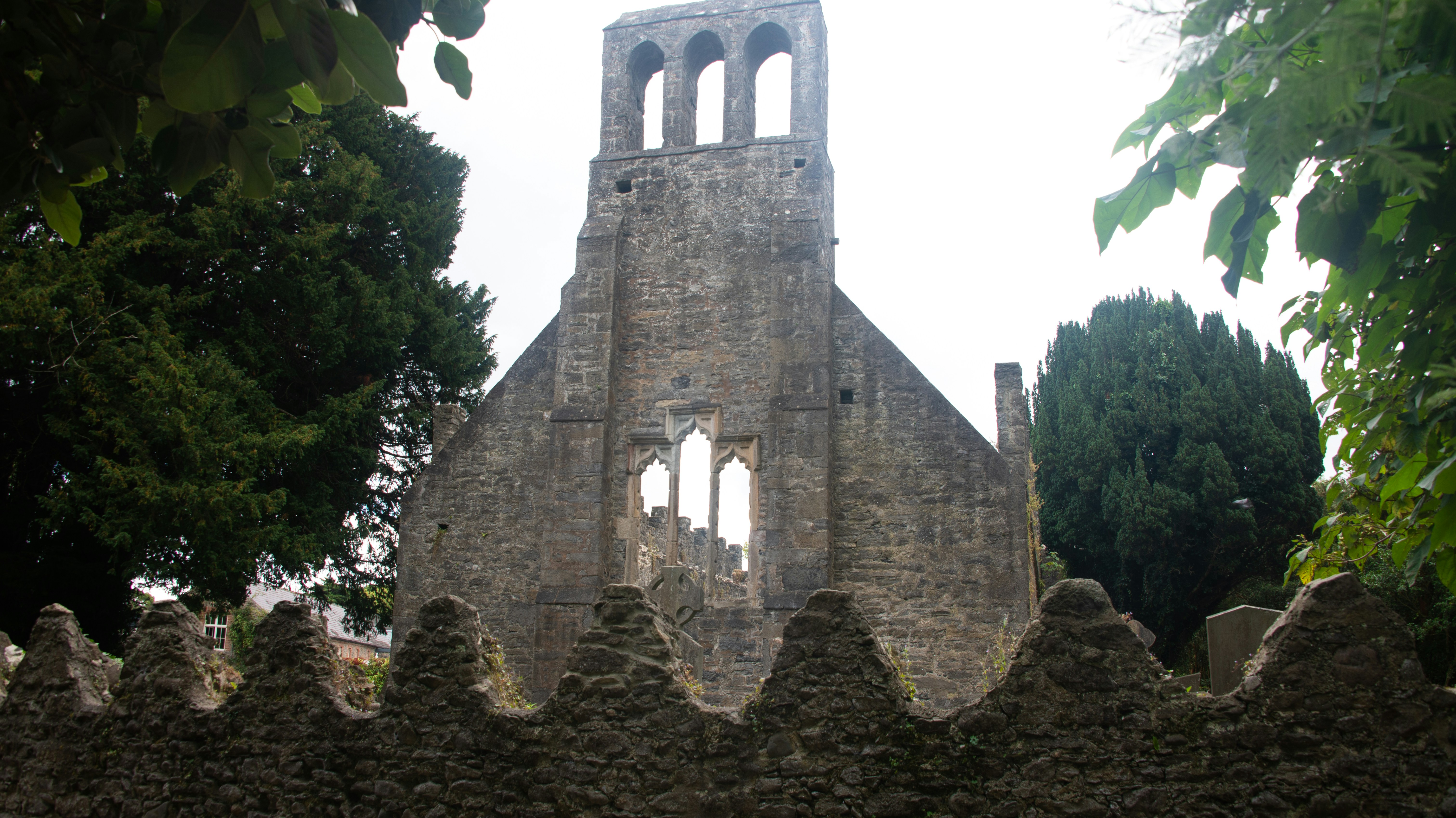 Ancient stone ruins of a church surrounded by trees
