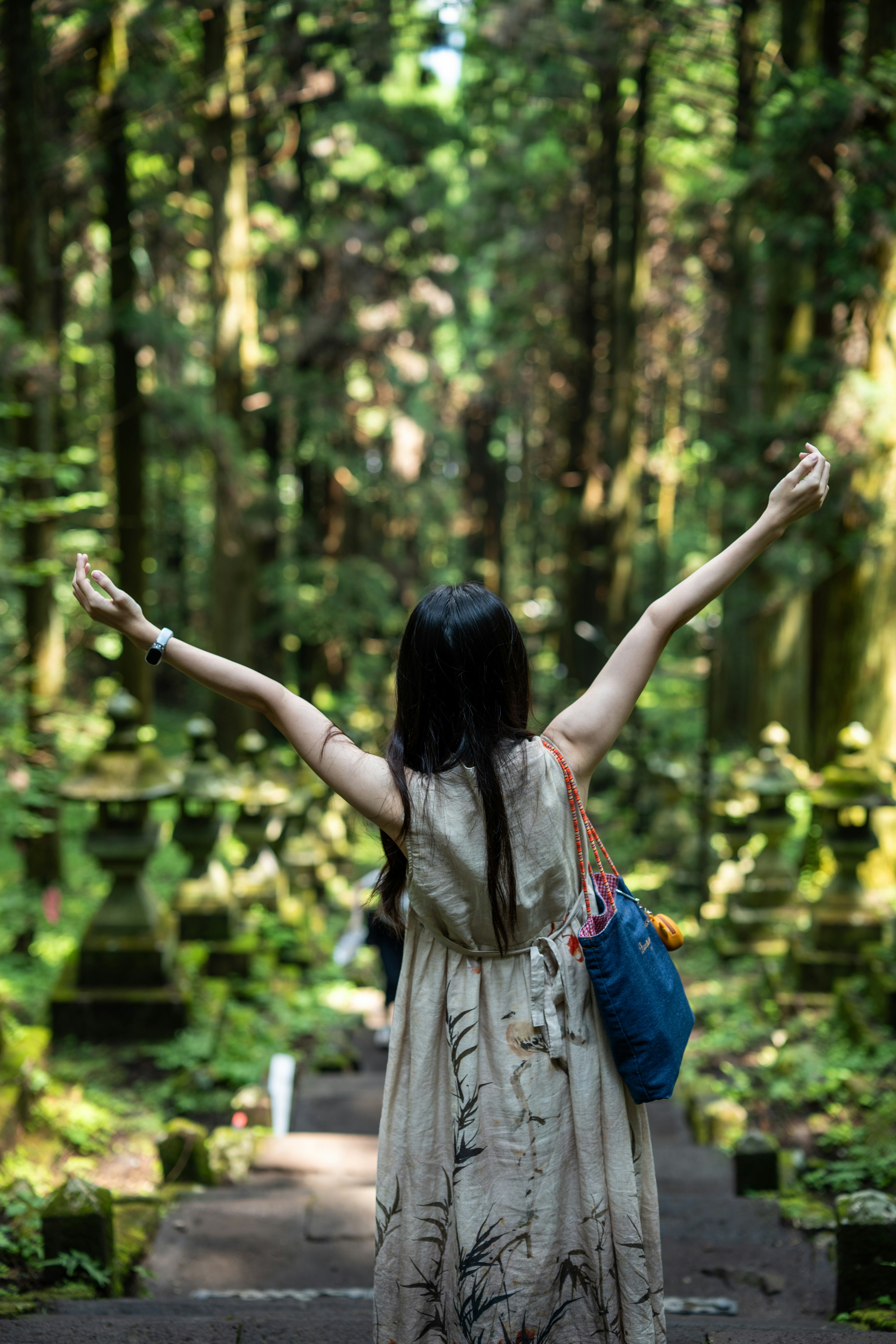 Arms Raised on a Moss-Cloaked Forest Path