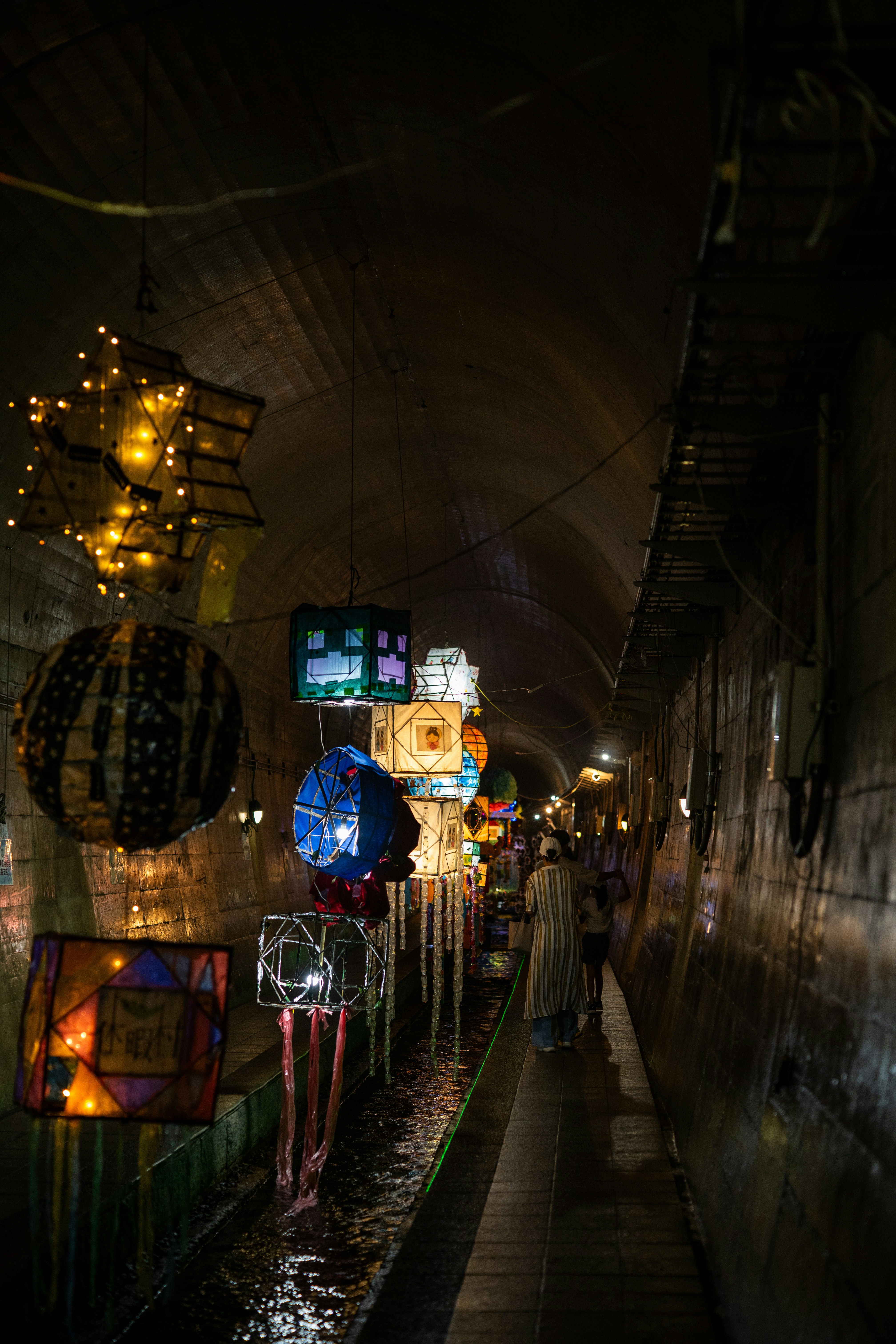Illuminated art installations in a dark tunnel