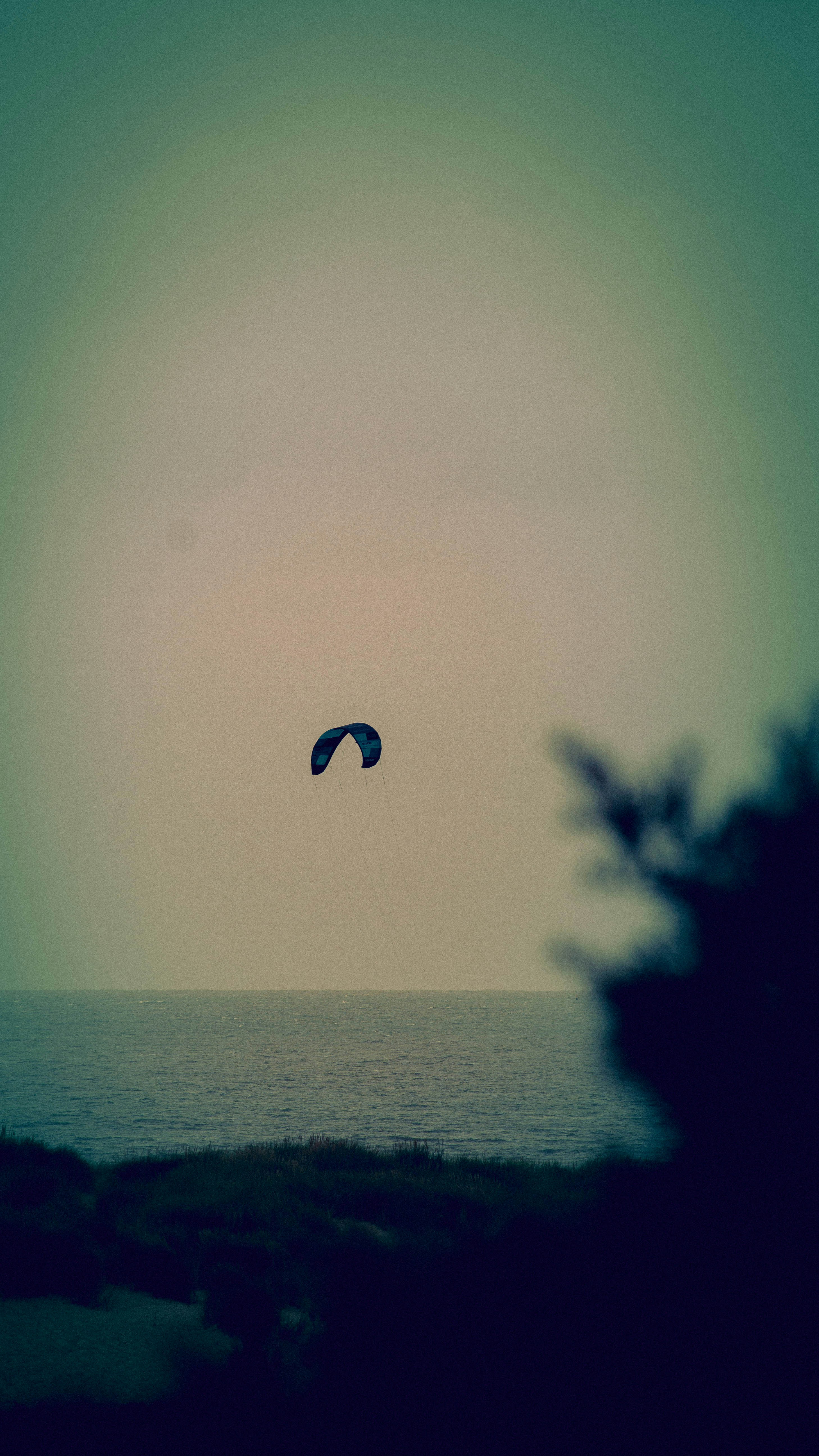 Kite surfer in the sky over the ocean
