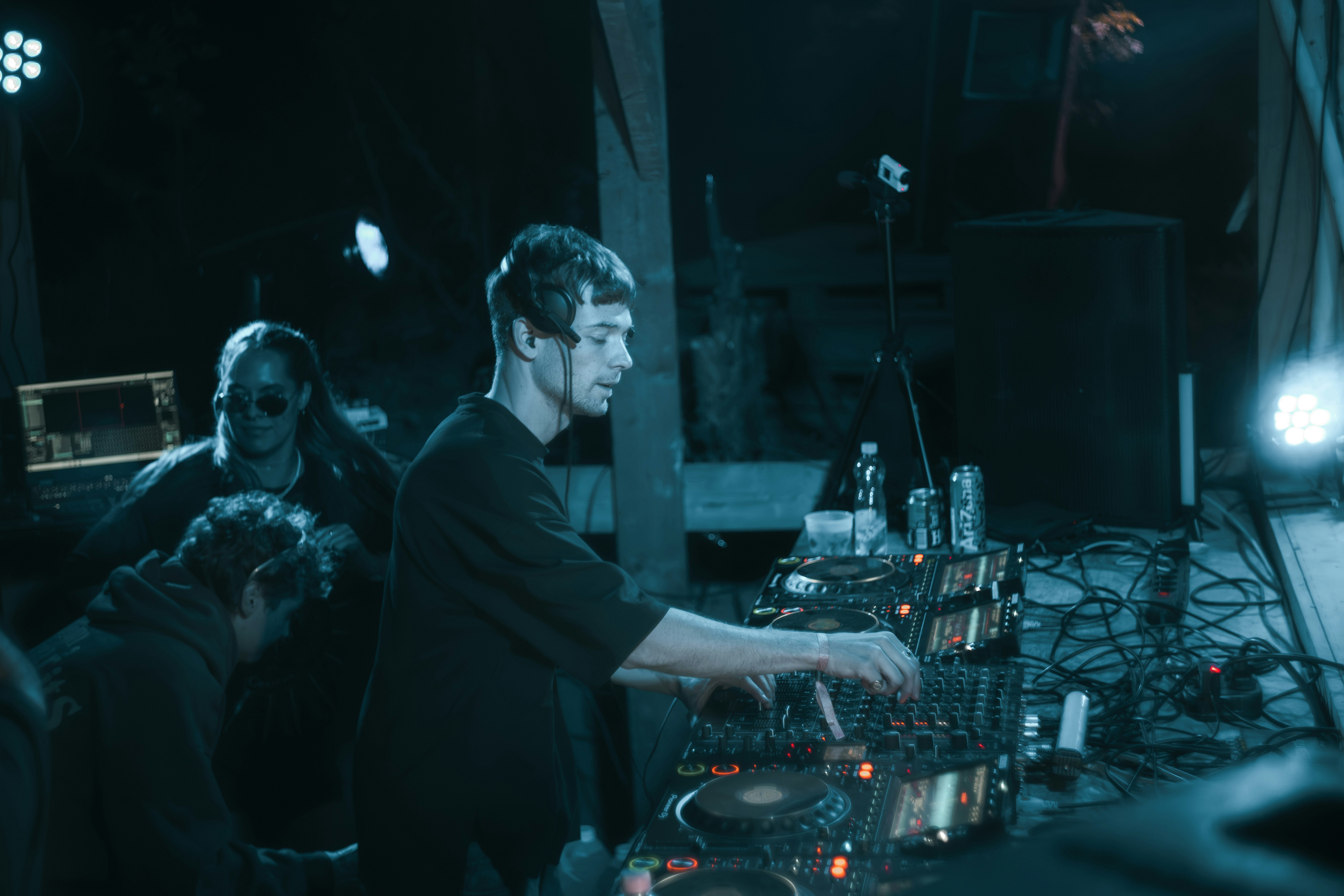 Dj performing at a music event with equipment