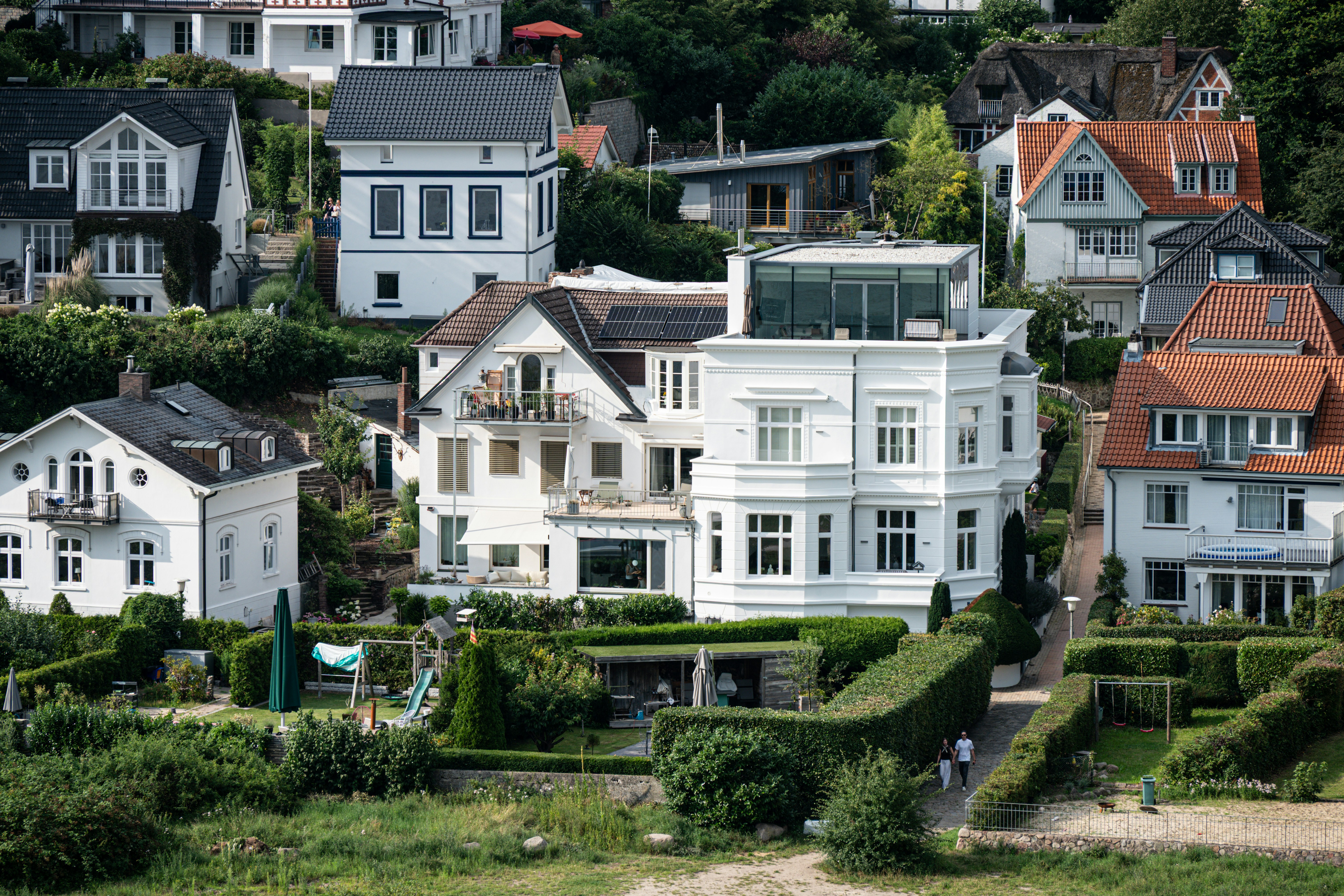 Elegant white houses on a lush green hillside