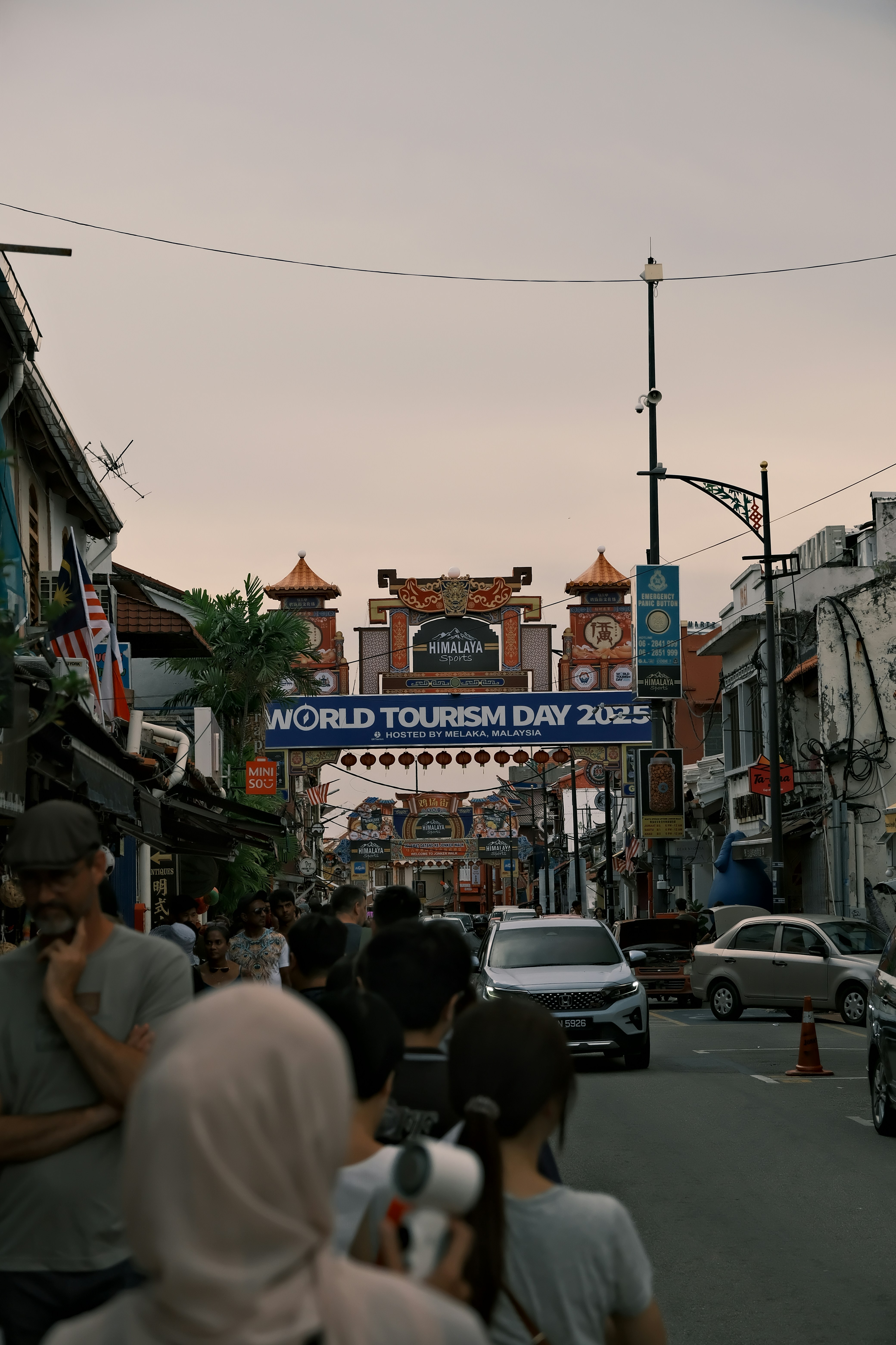 Busy street with people and an archway