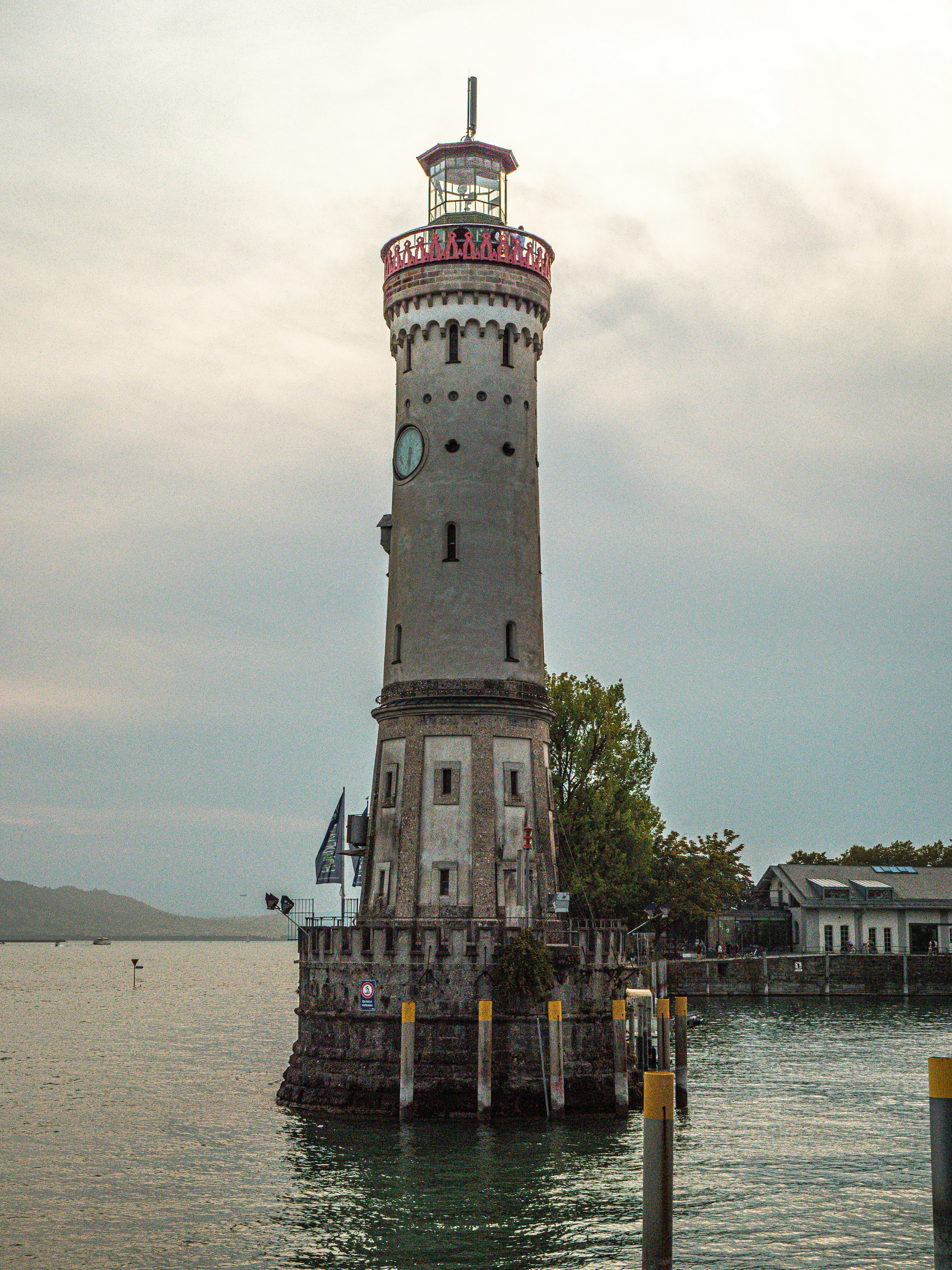 Lighthouse standing tall on a pier by the water