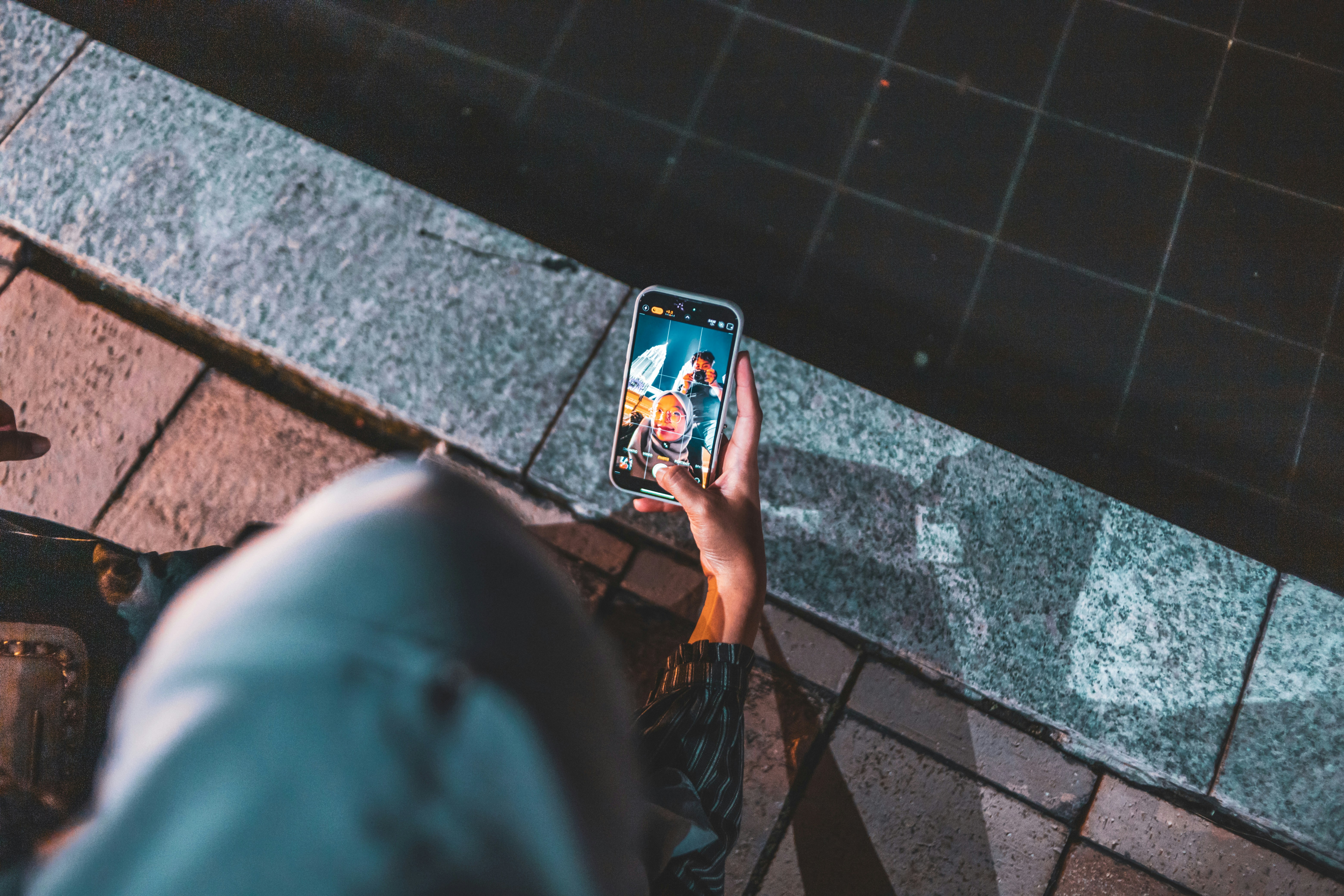 Person holding phone to record something