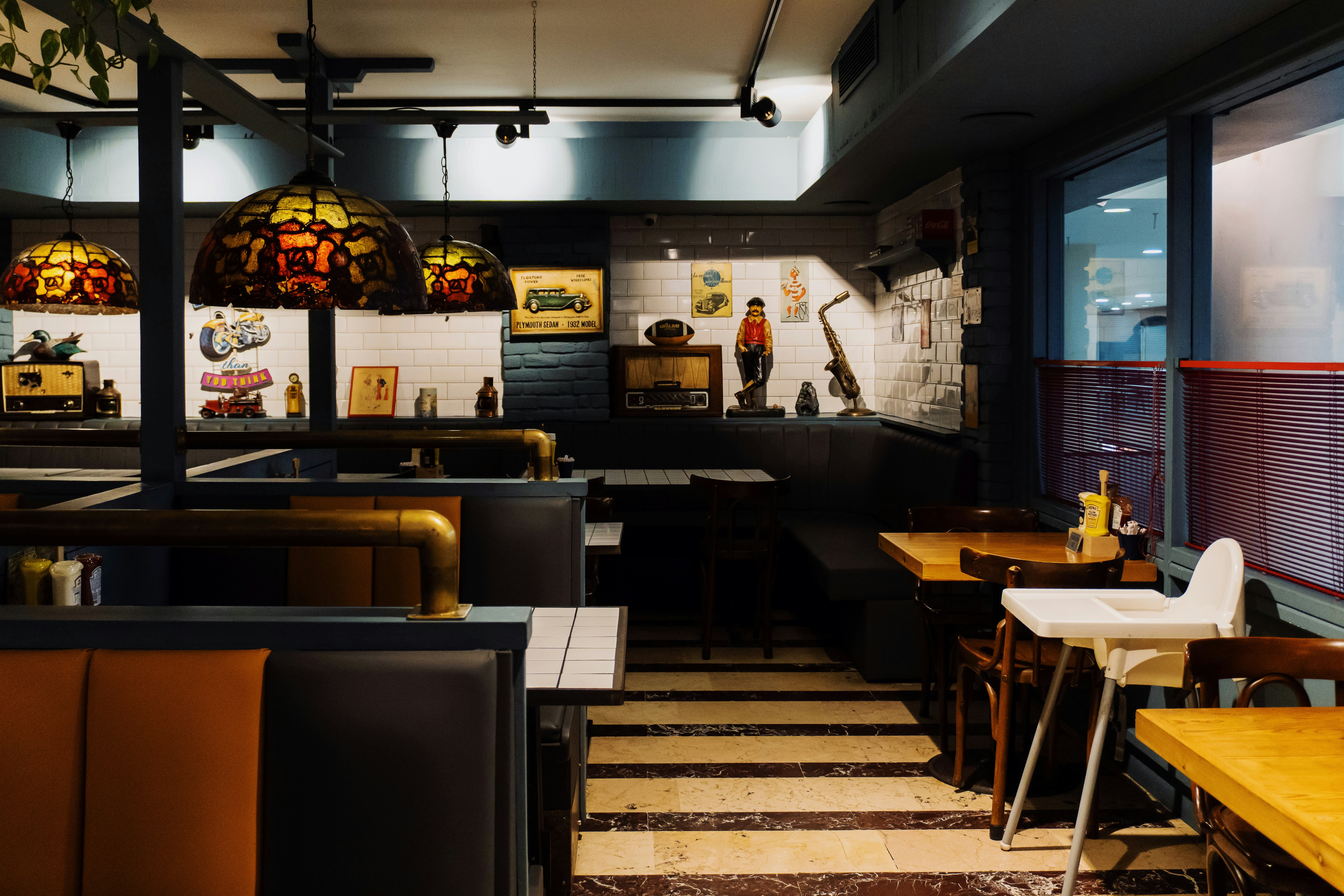 Inside a classic American burger joint. | Cozy booth seating in a dimly lit restaurant interior.