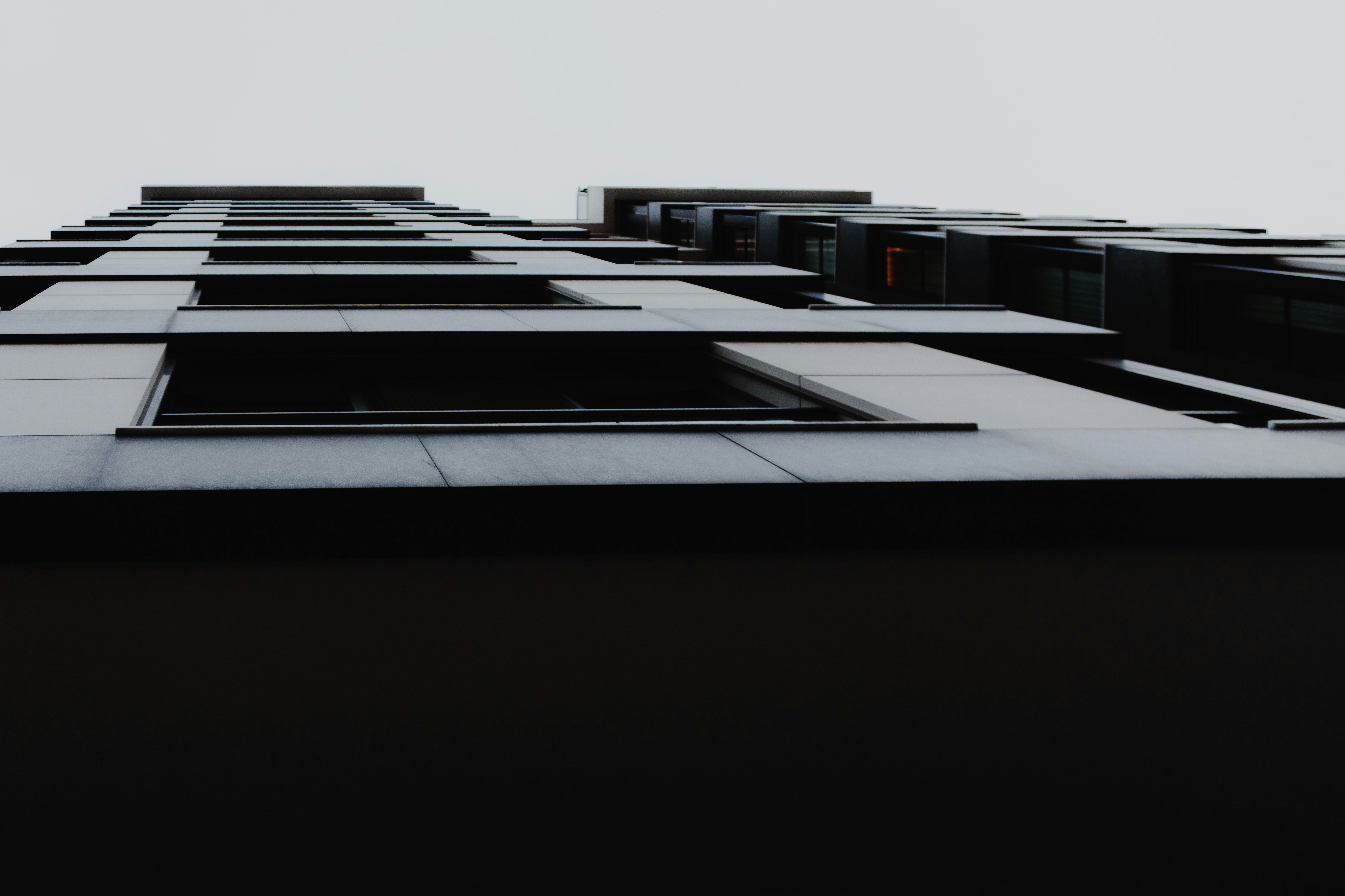 A building turning into pure geometry. | Looking up at a modern building with many windows