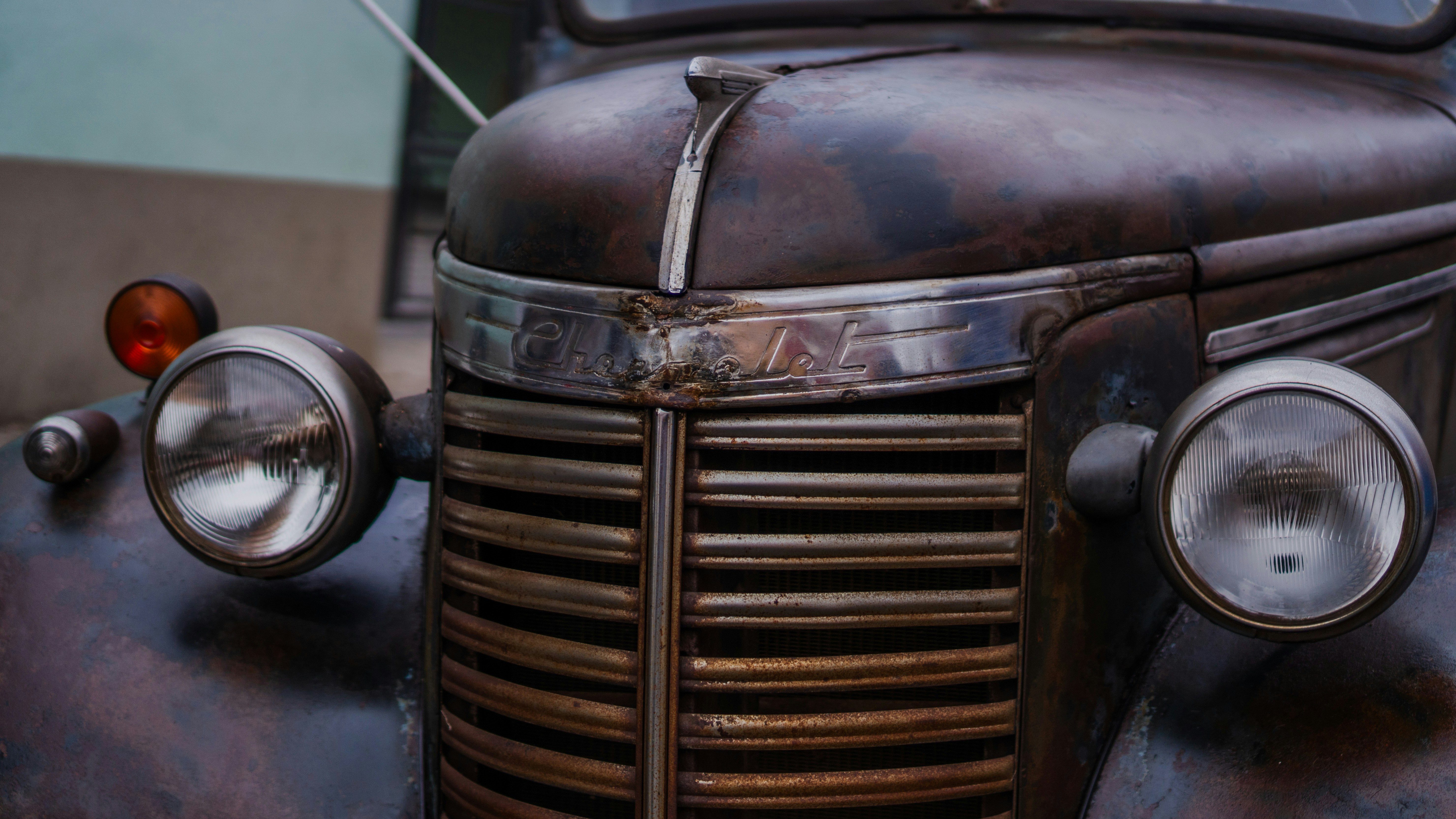Close-up of a rusty vintage car grille and headlights