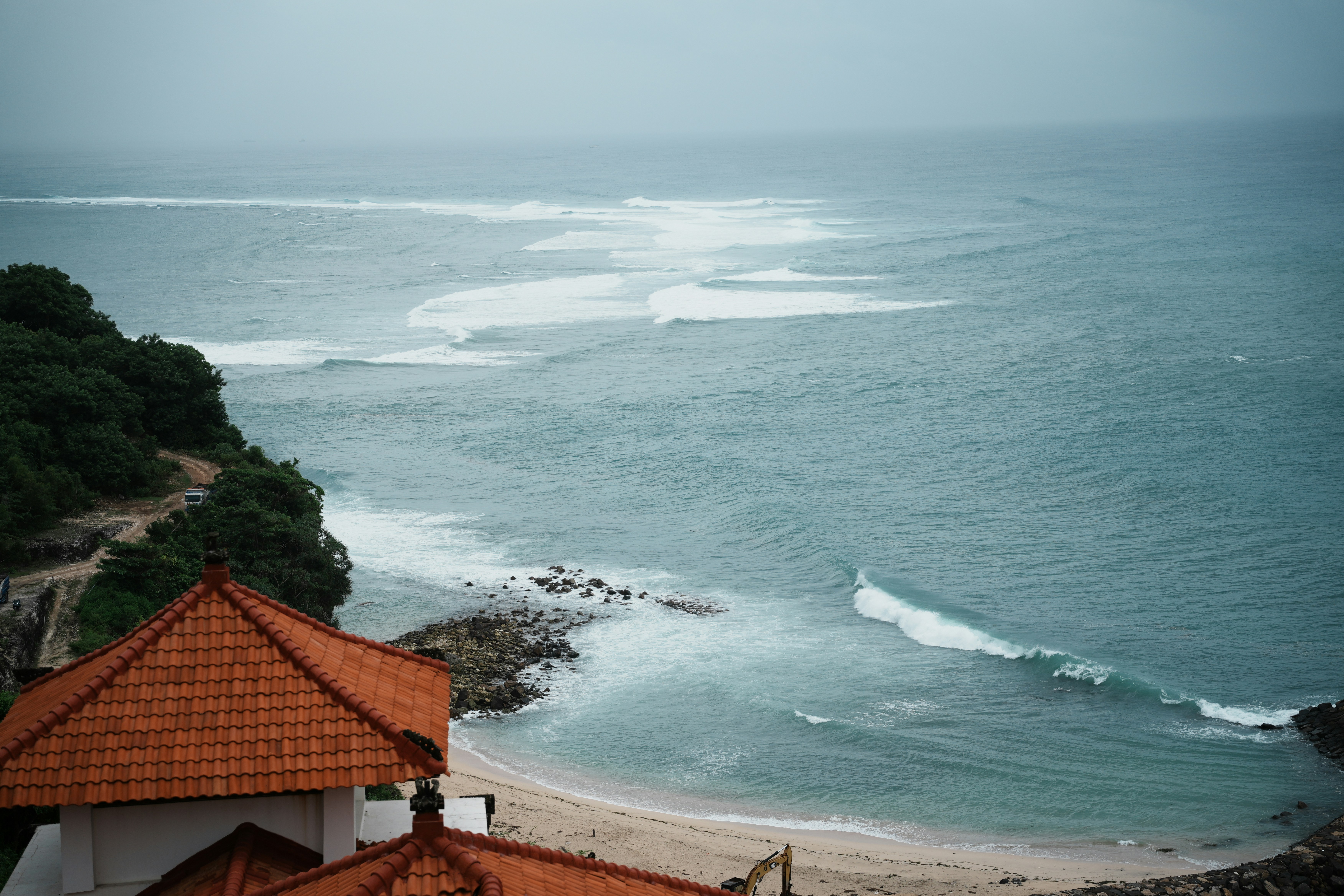Coastal view with a building and ocean waves