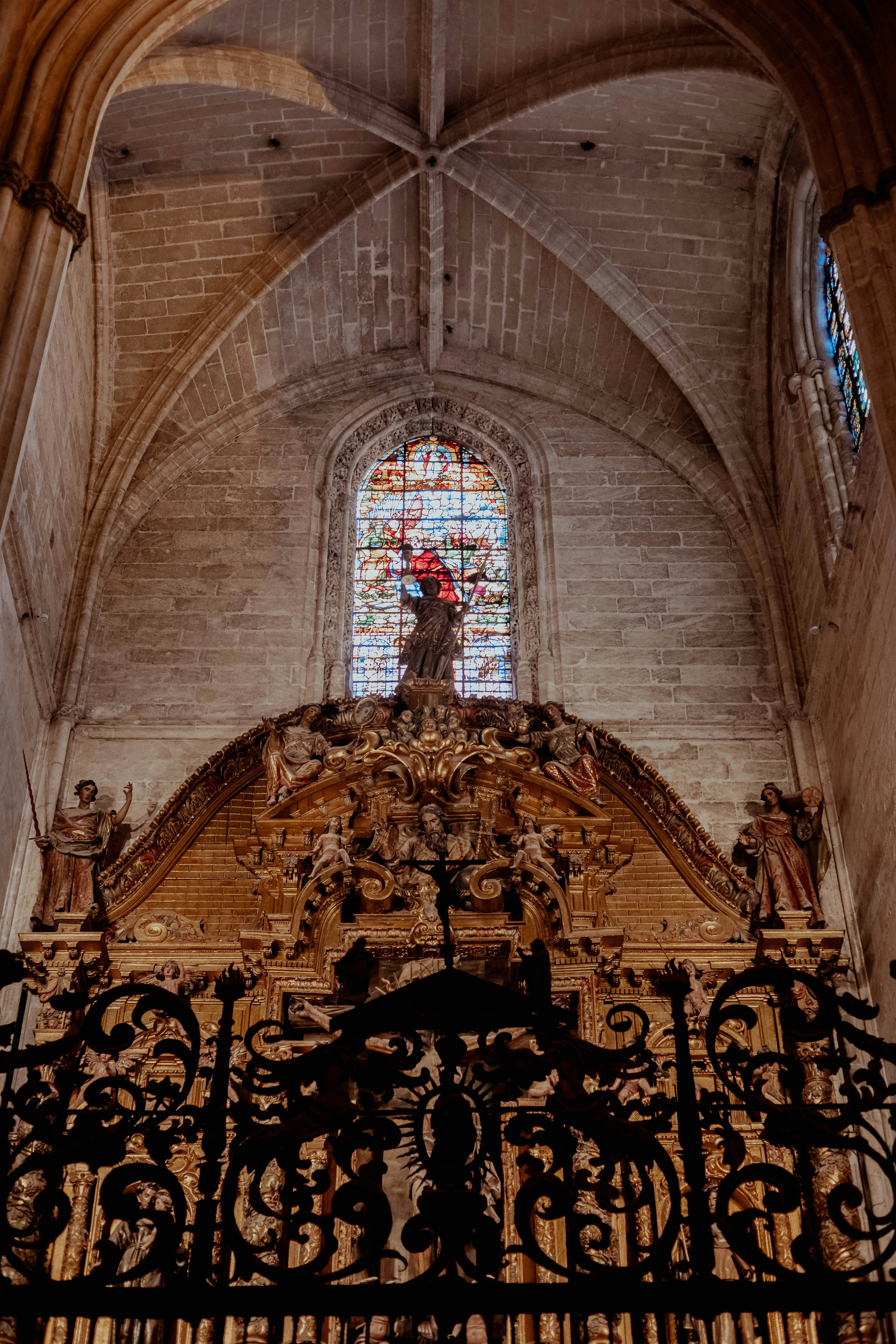 Ornate altar with stained glass window above