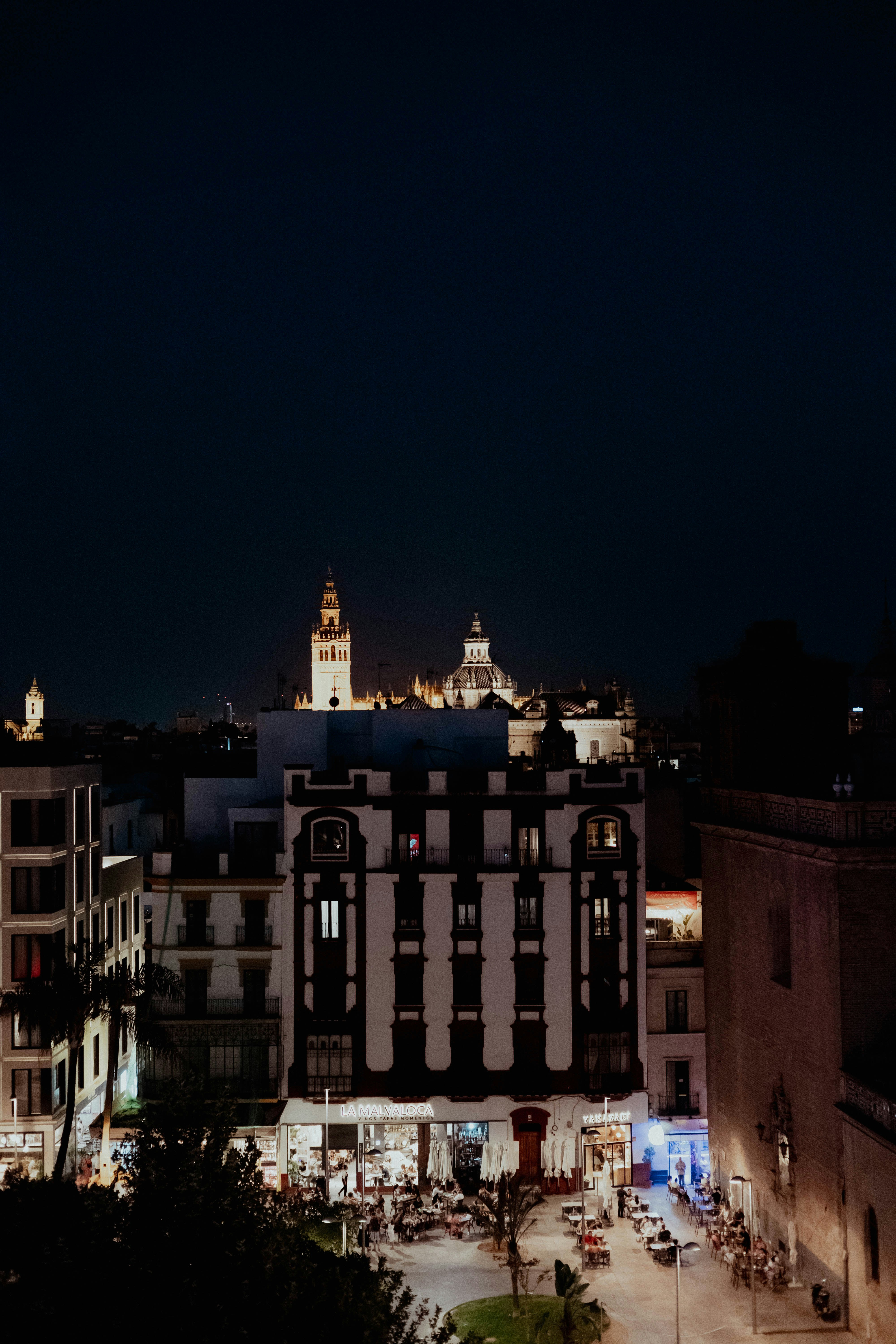 Horizon Spires Over a Lantern-Lit Plaza
