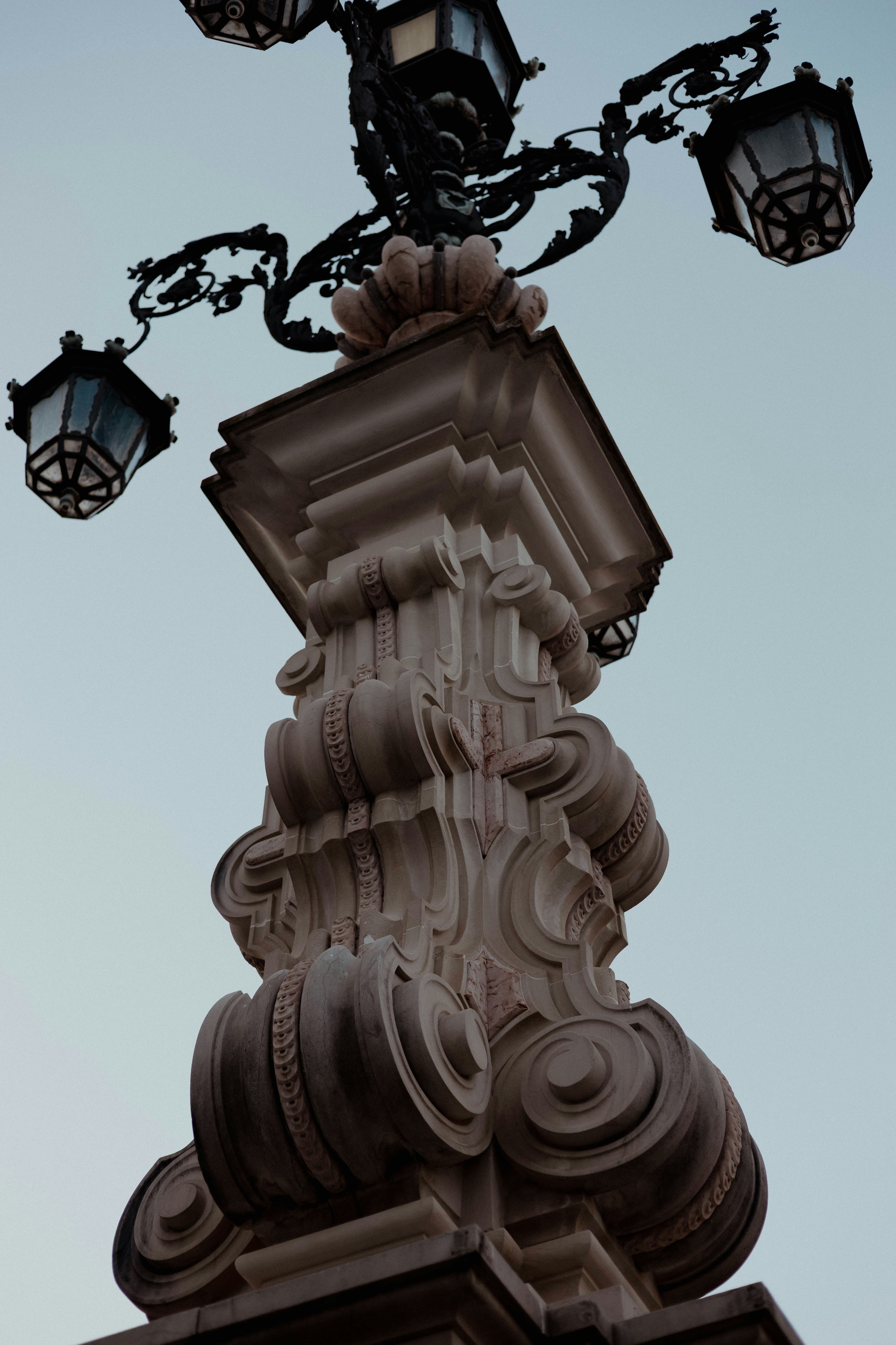 Ornate lamp-post in a pale evening sky