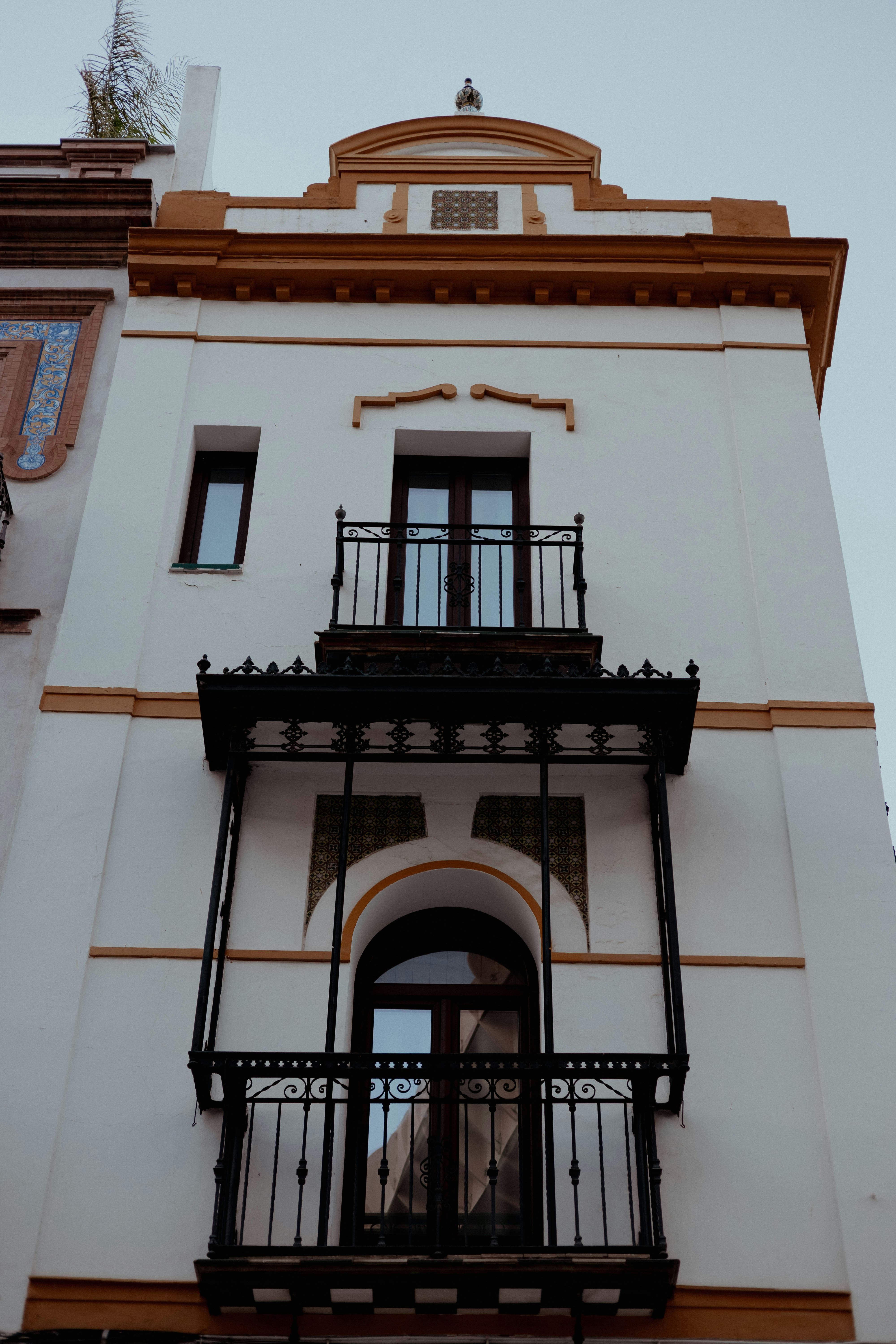 Intricately designed balcony on a historic building showcases ornate ironwork and classic architectural features.