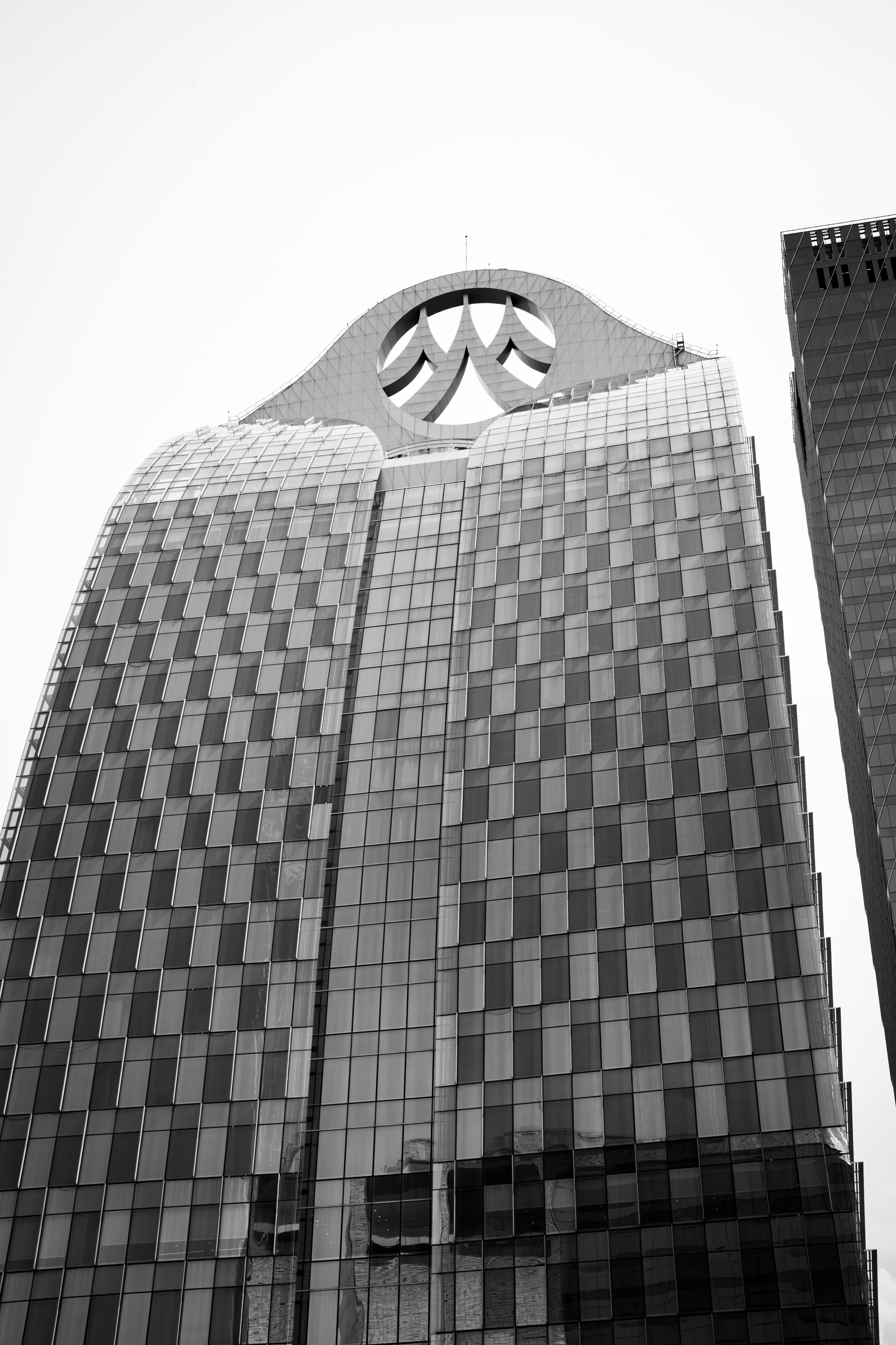 Crescent Crown: The arched crest atop a glass-clad skyscraper