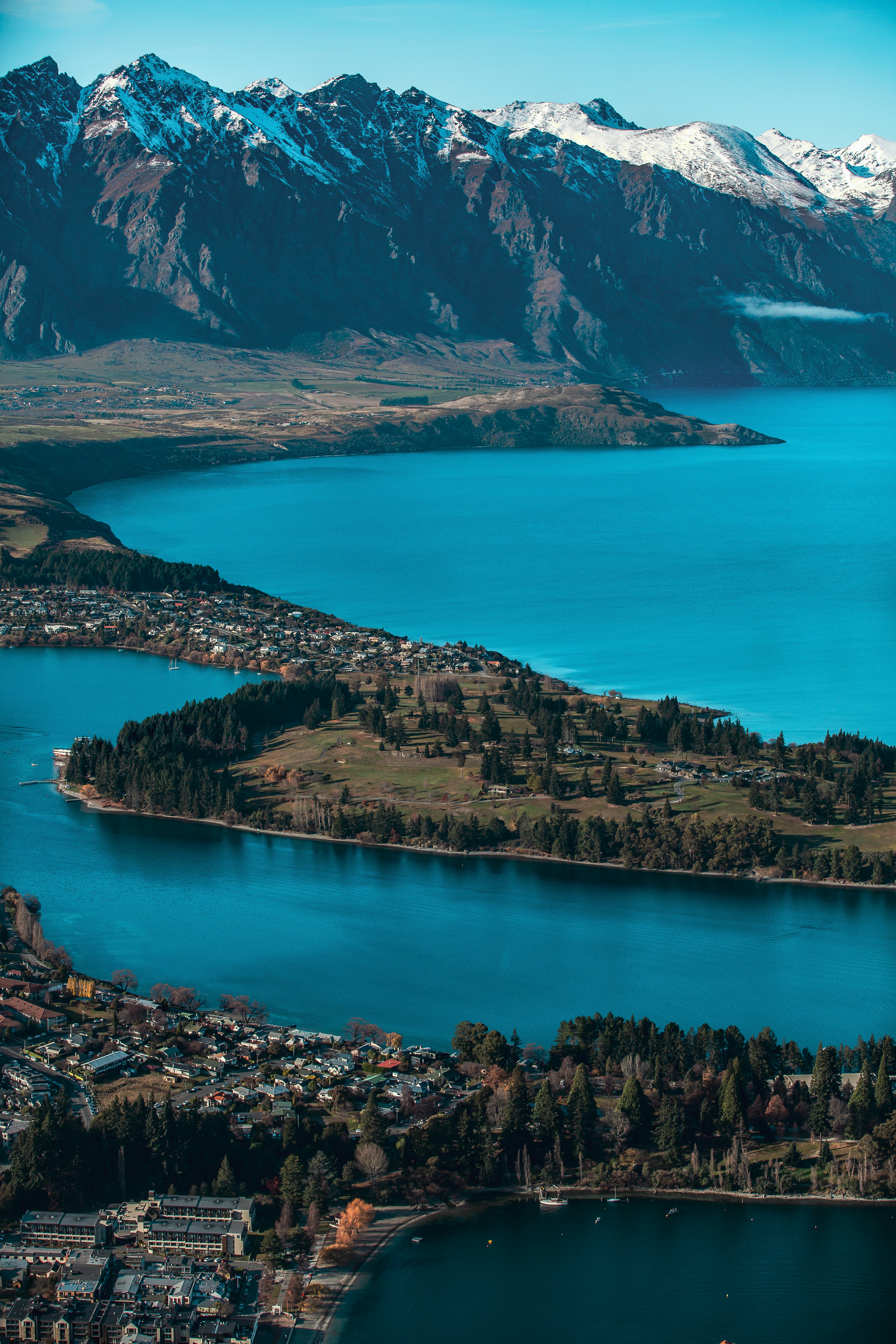 Queenstown from above | A scenic view of a blue lake and snow-capped mountains.