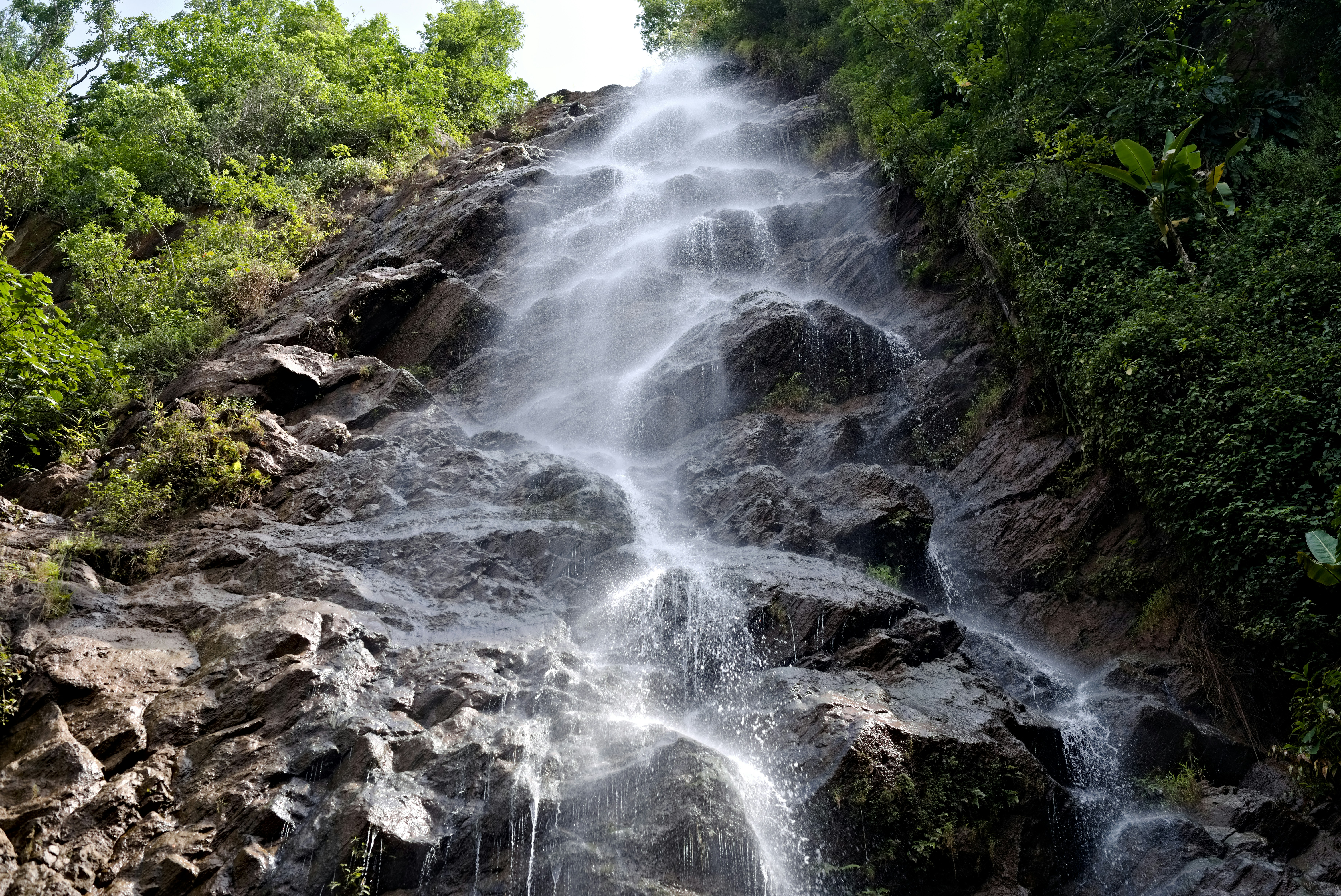 Cascade Veil: A Rock-Strewn Descent Over Graceful Steps
