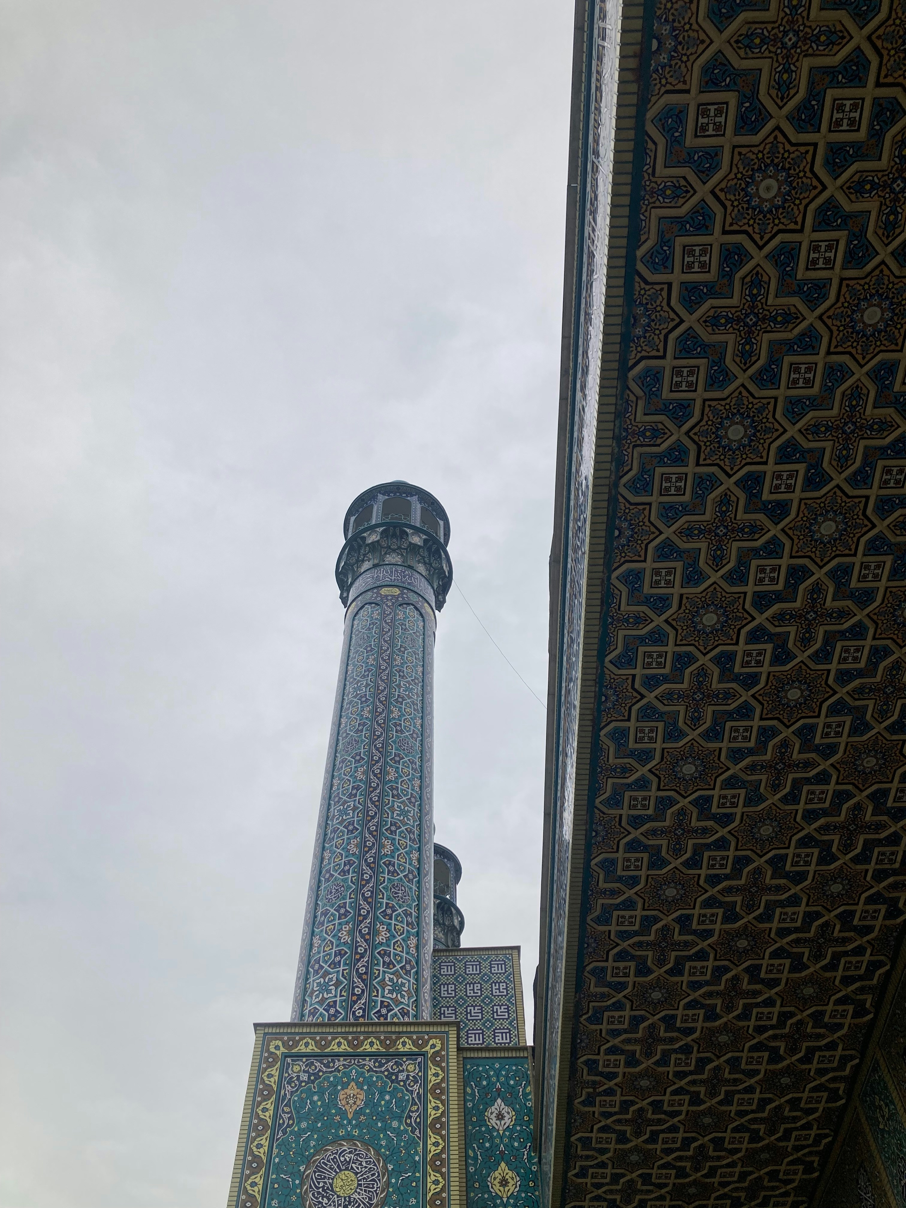 A tall minaret with intricate blue and white tilework