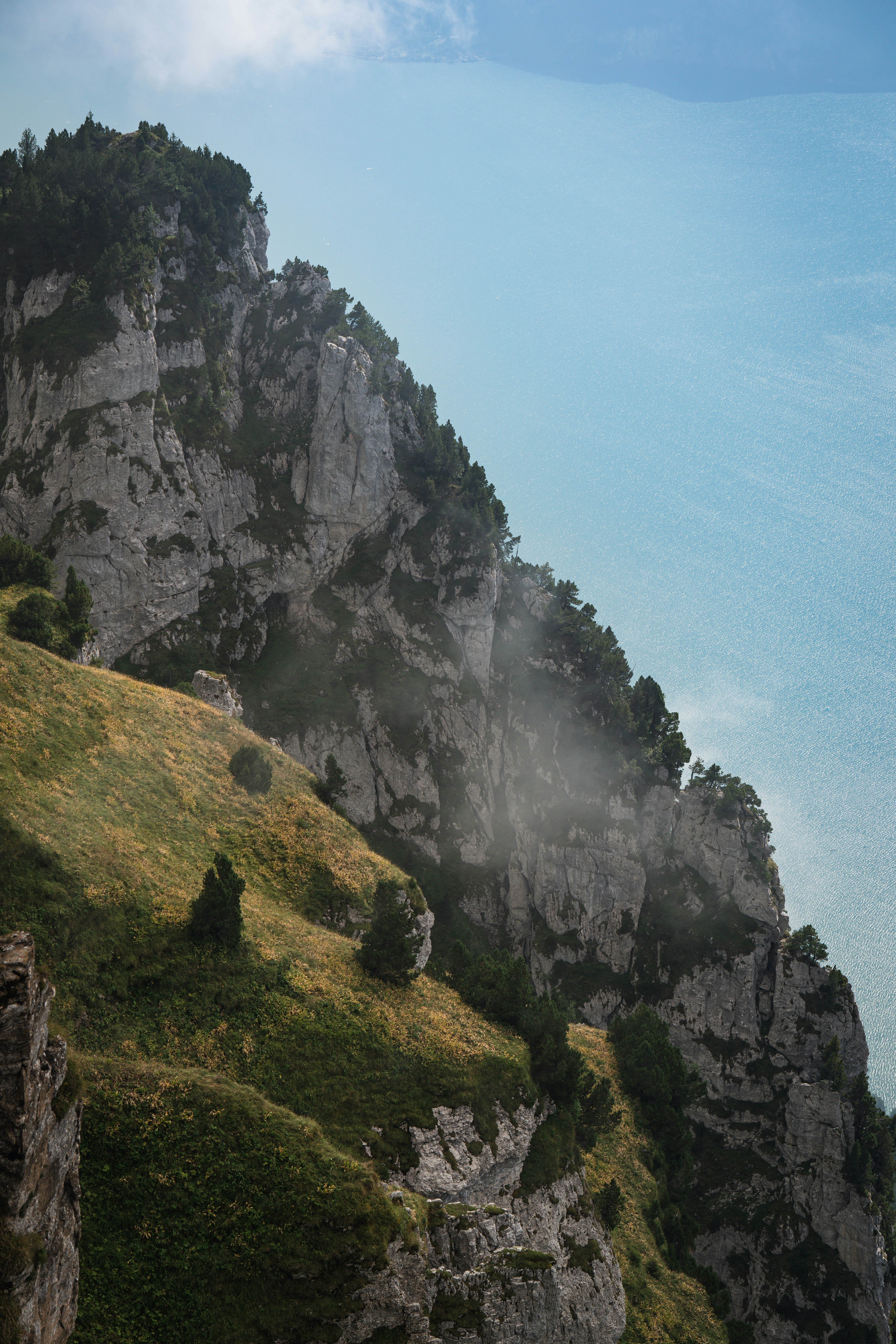 Jagged mountain range with green slopes under sky