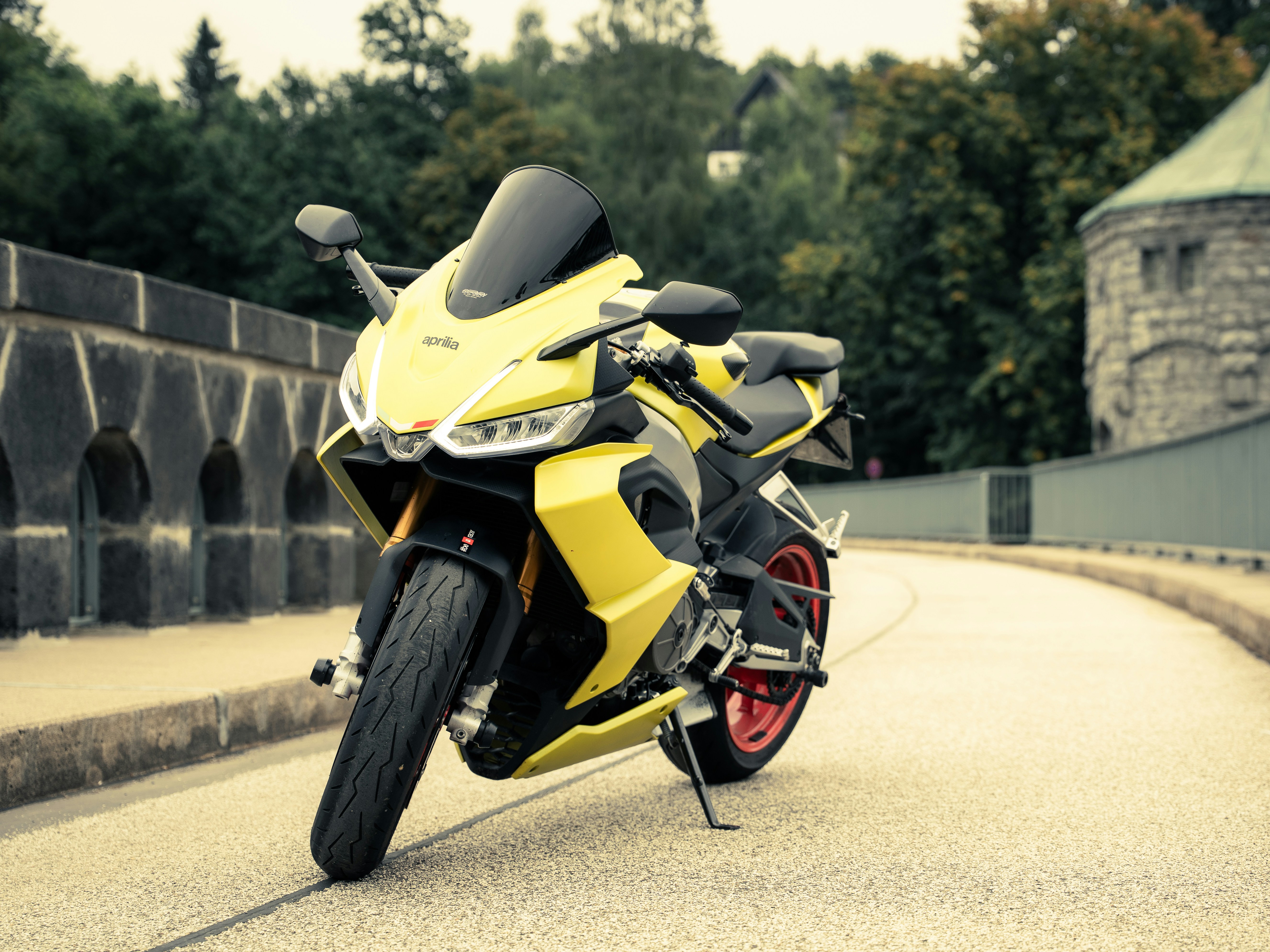 Yellow sport motorcycle parked on a bridge