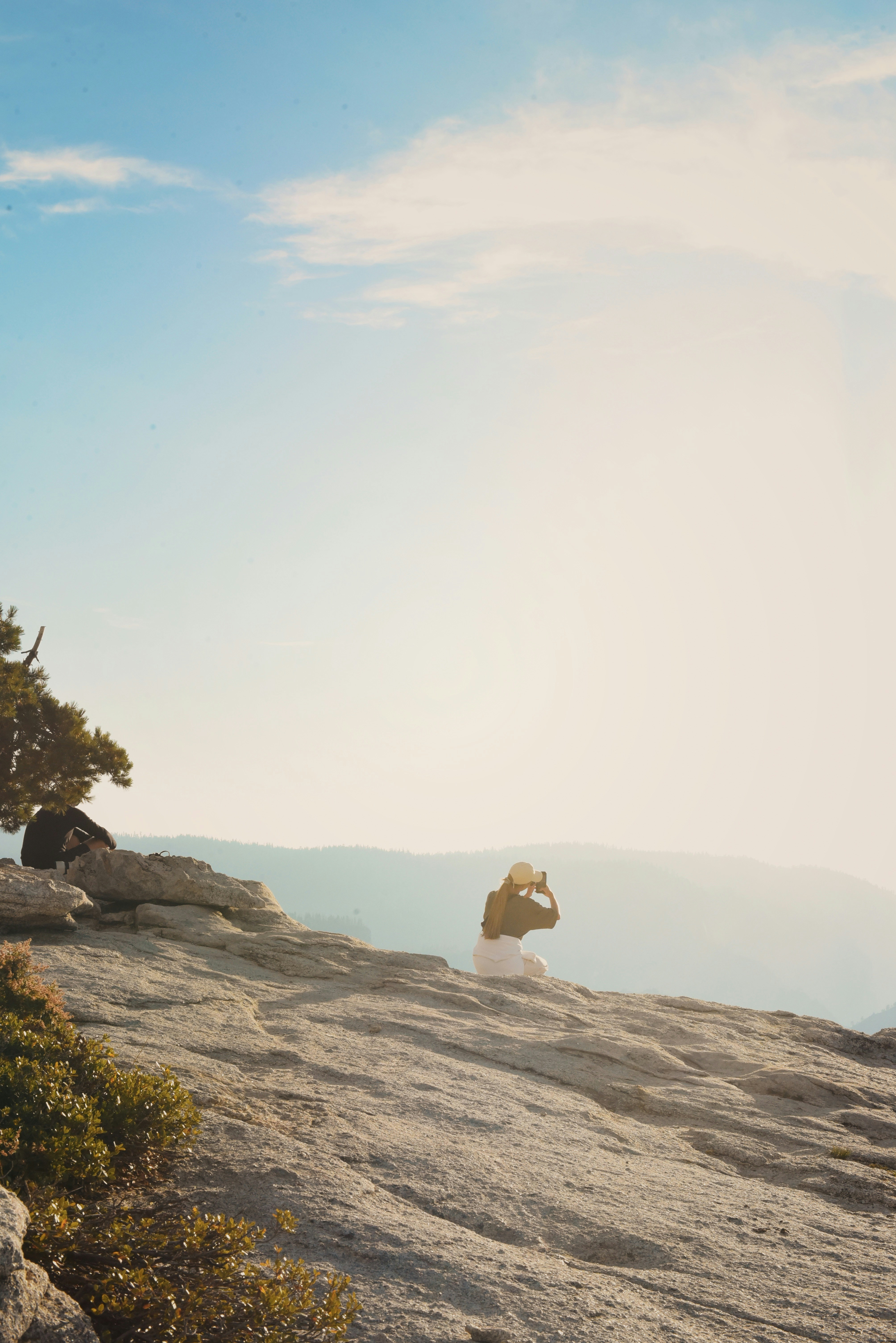 The Photographer’s Silence | Hikers admire mountain vista from rocky overlook