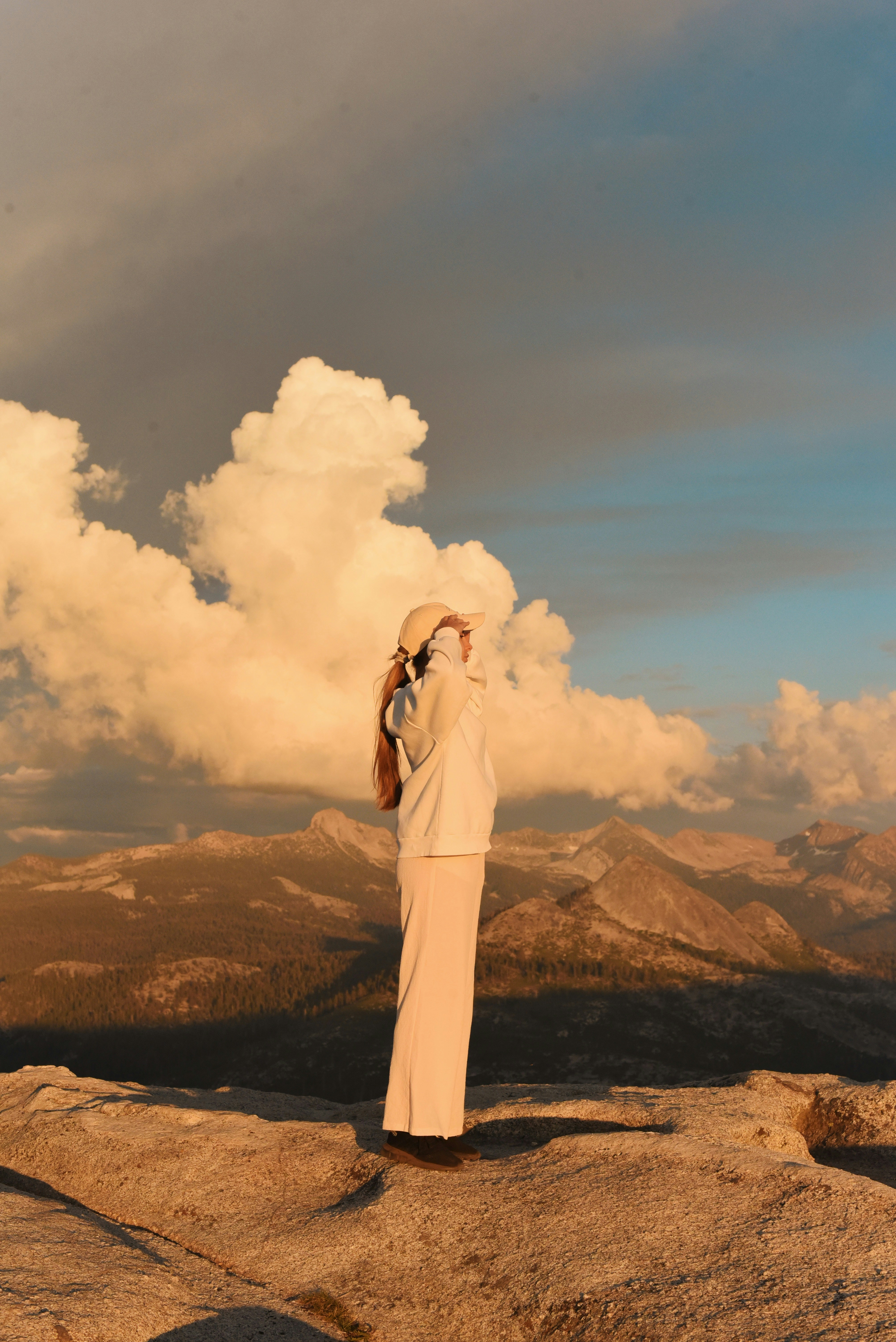 Woman in hat watches sunset over mountain landscape photo – Free Woman ...