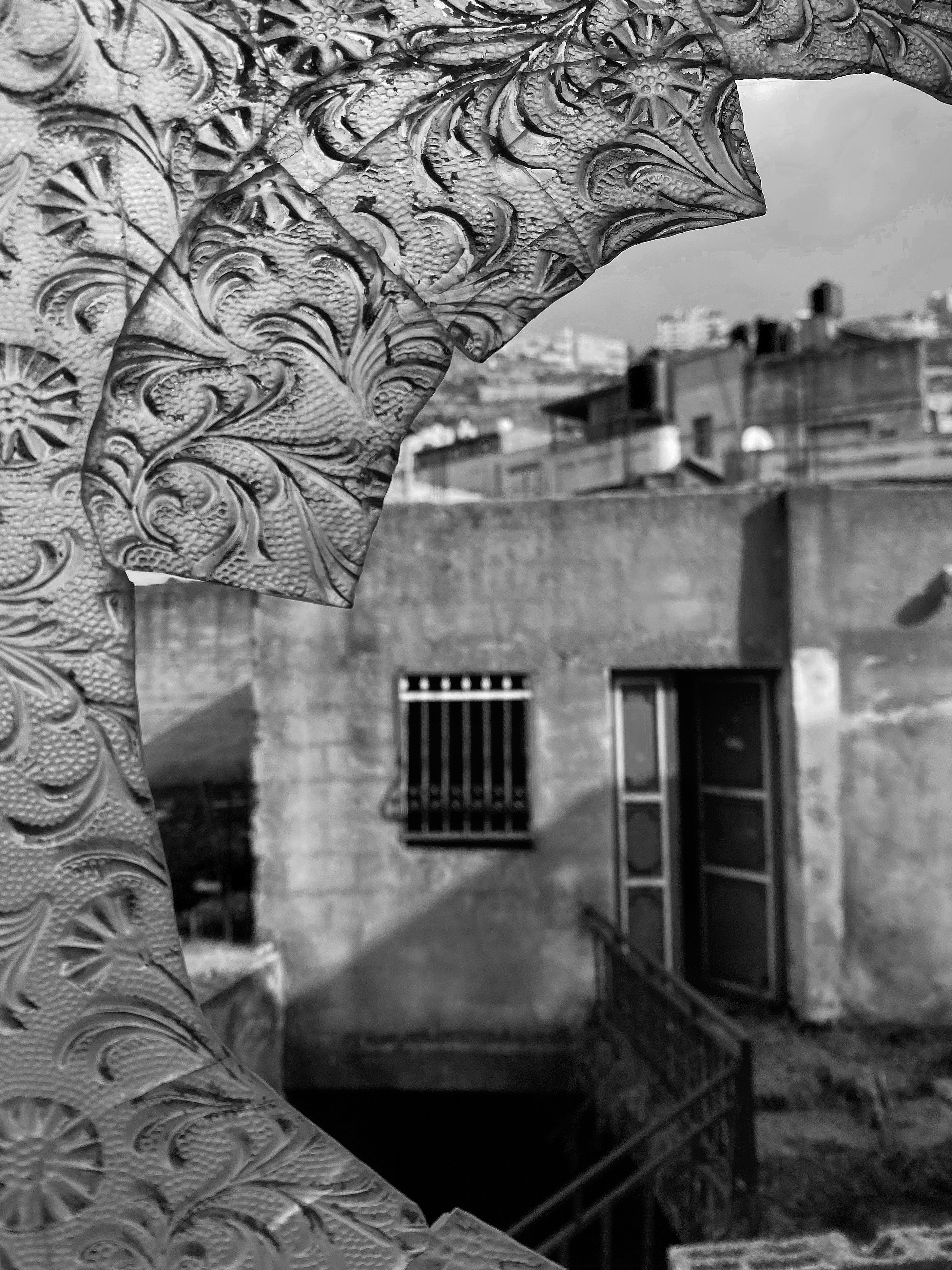 what have crossed your mind? | Ornate pattern overlays a weathered building facade.