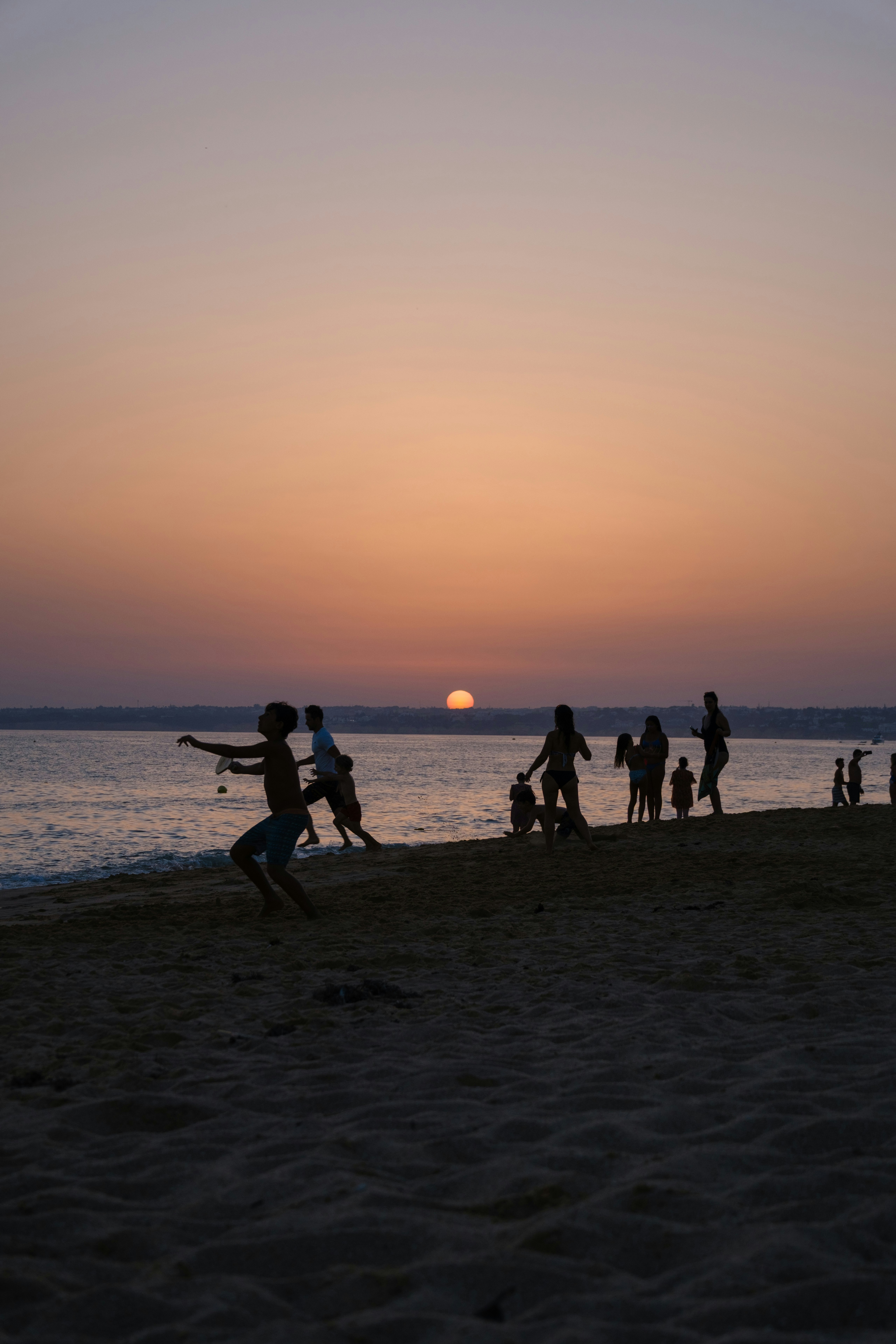 Dusk on the Beach: Silhouettes Against a Quiet Sunset