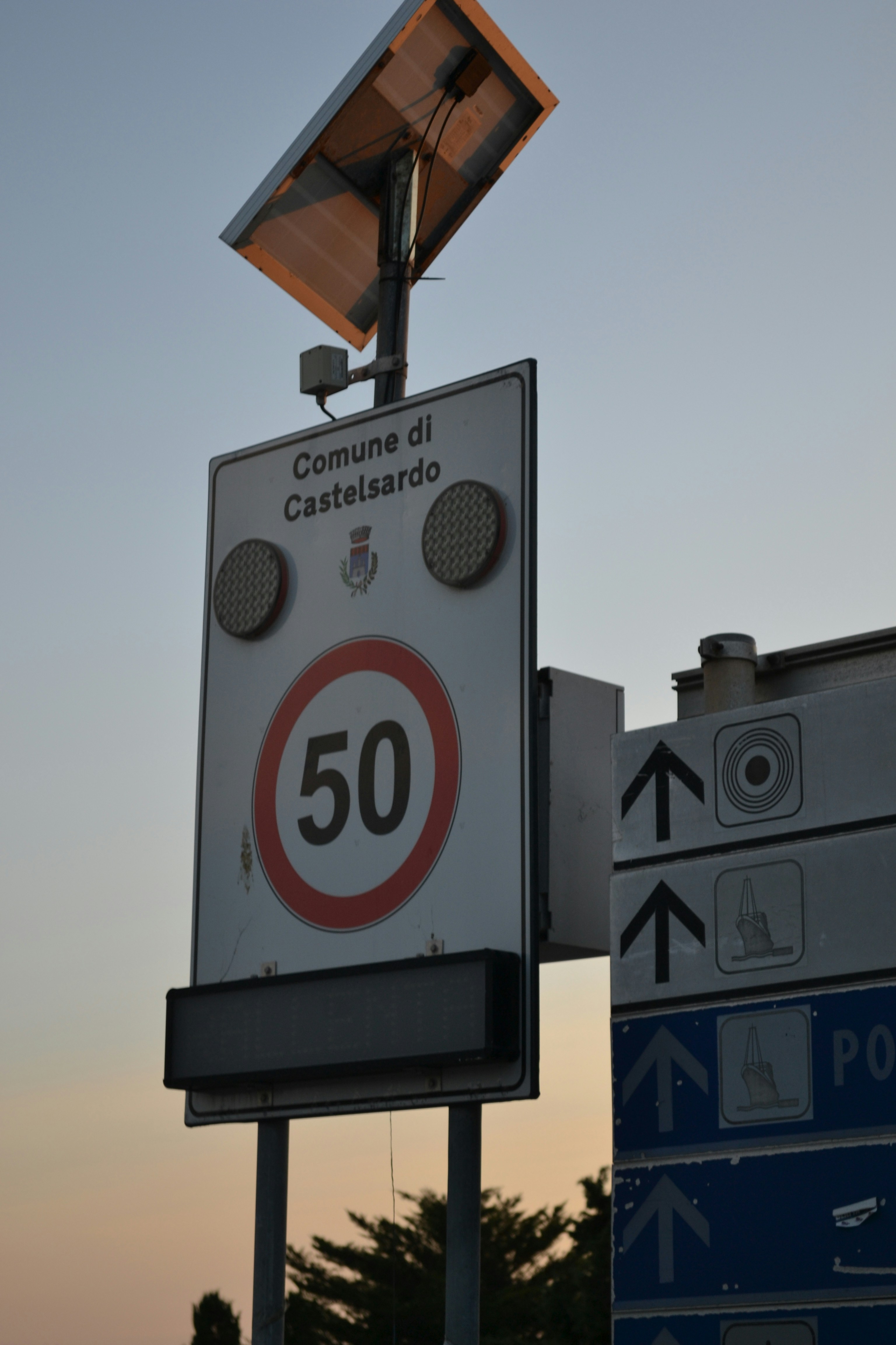Speed limit sign with solar panel at dusk