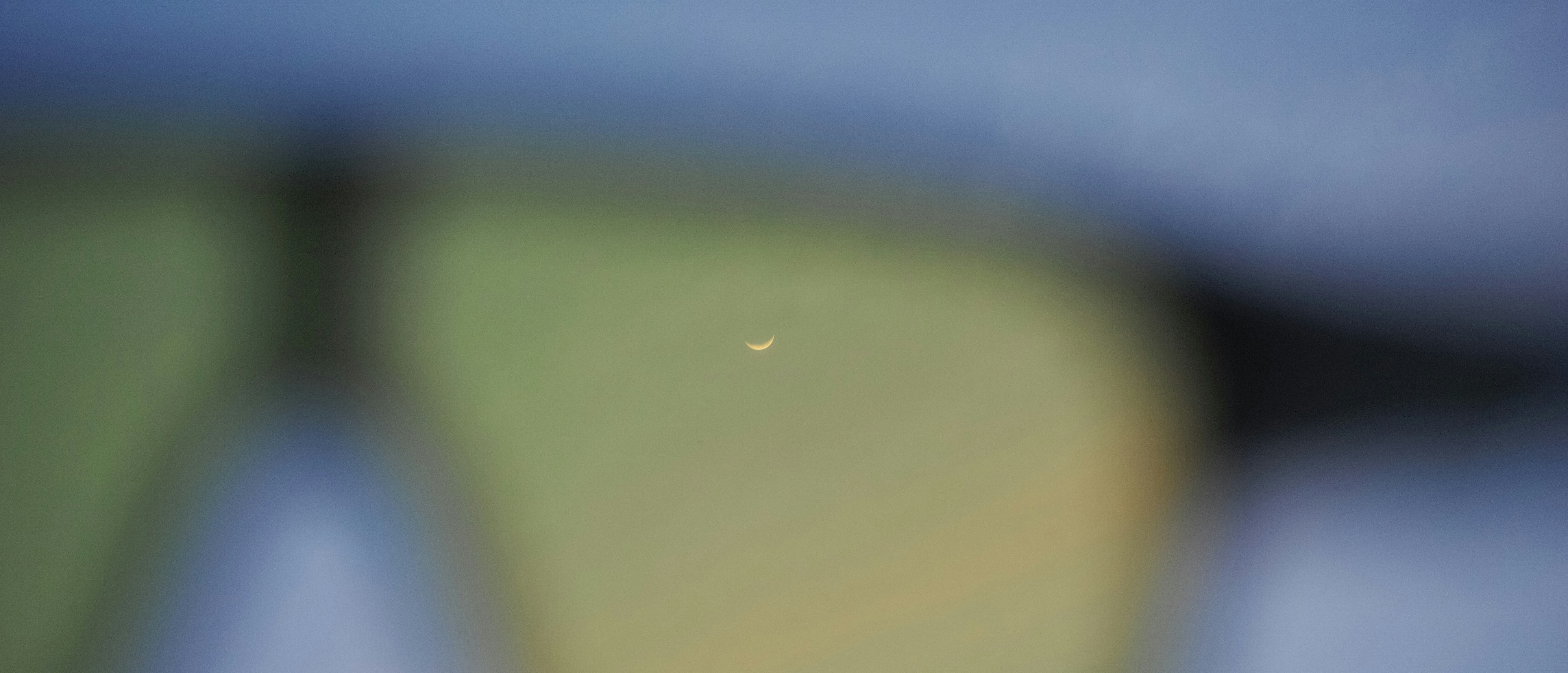 A tiny speck of light against a blurred background.