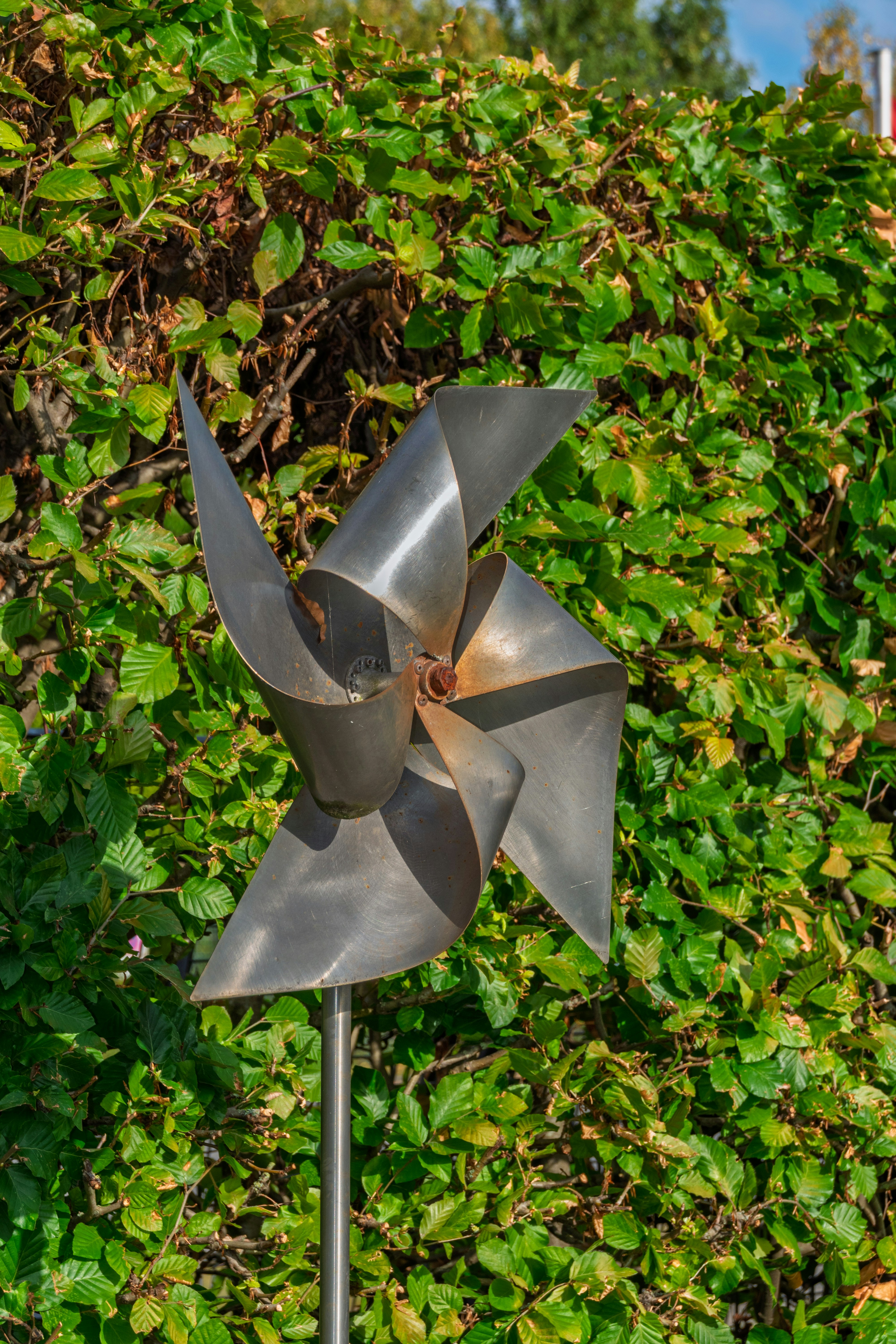 Whirling Metal Dance: A Modern Garden Sculpture