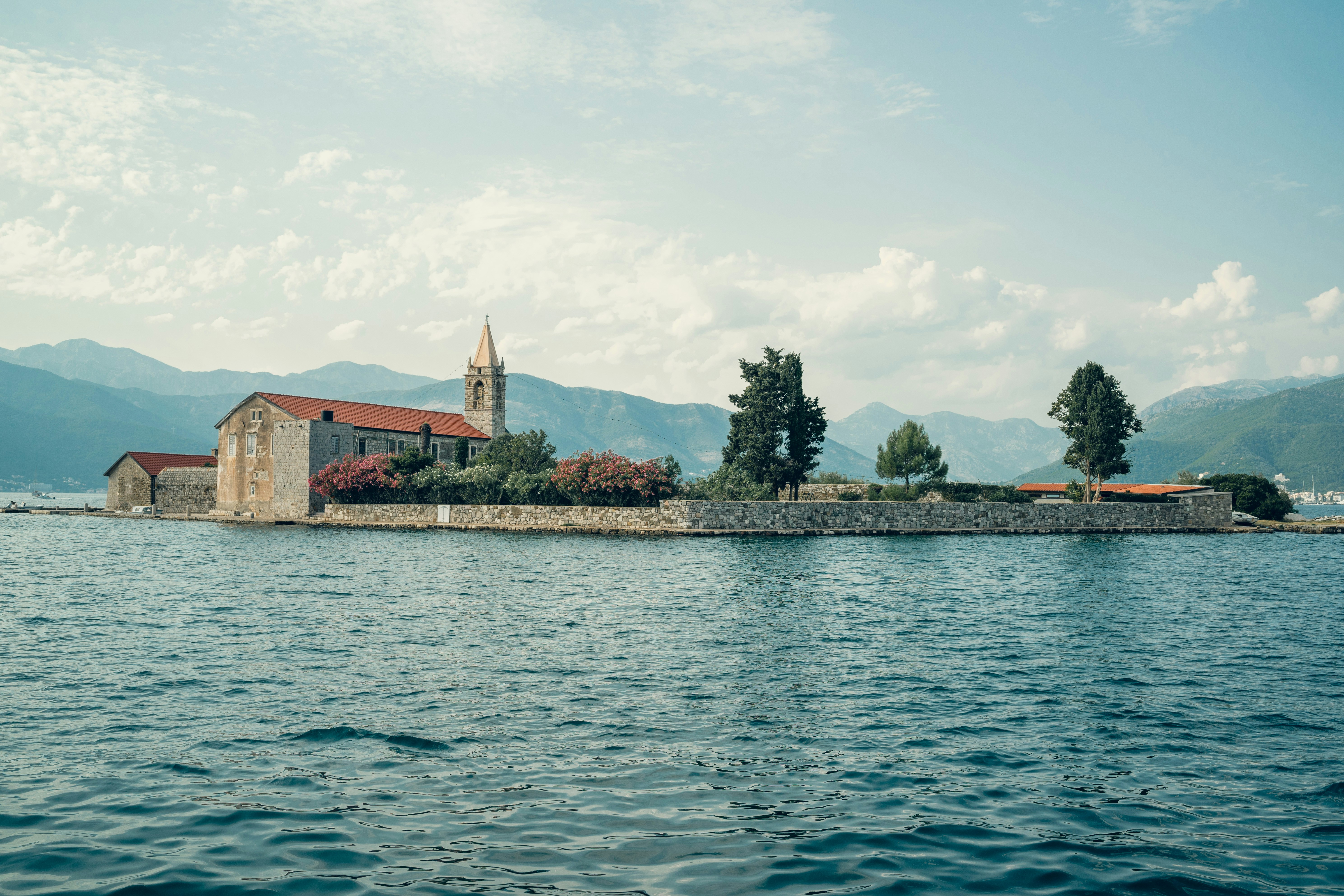 Island with church and trees on a sunny day