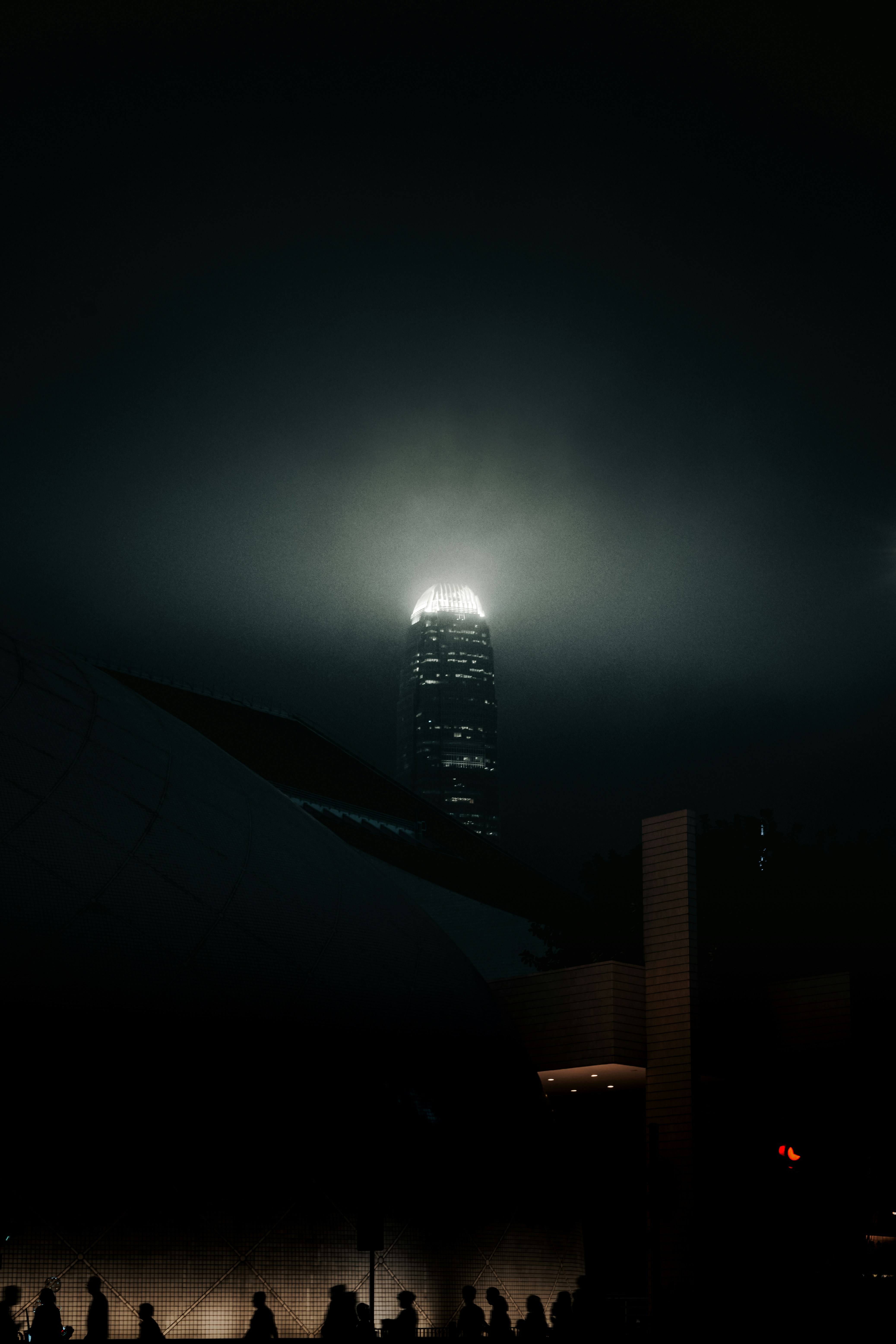 Hong Kong Street View - Sun Hung | Skyscraper illuminated by bright light through fog